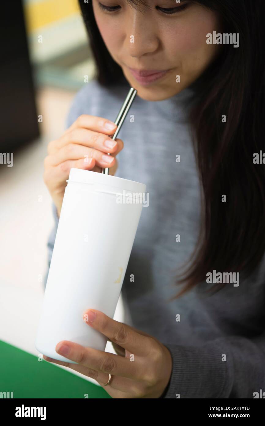 Woman drinking reusable straw Stock Photo - Alamy