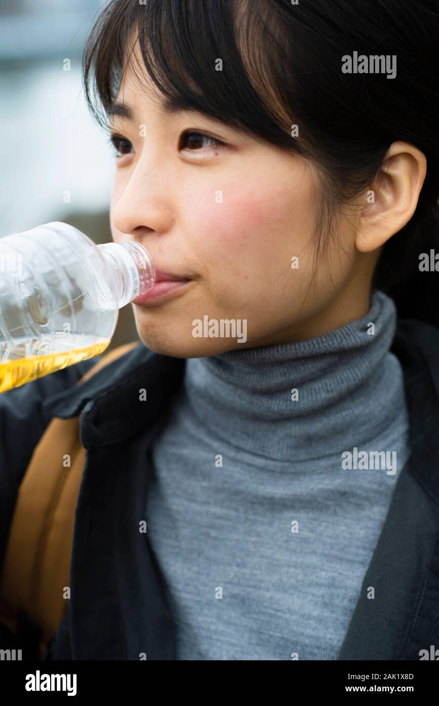 Woman drinking mugicha, Japanese roasted and iced barley tea Stock ...