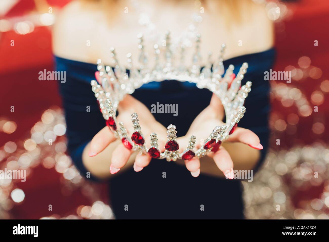 Woman girl holding above a head the golden crown. Leadership, success ...