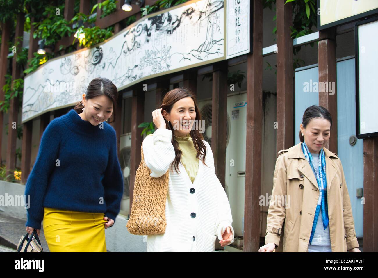 Women walking through town Stock Photo - Alamy