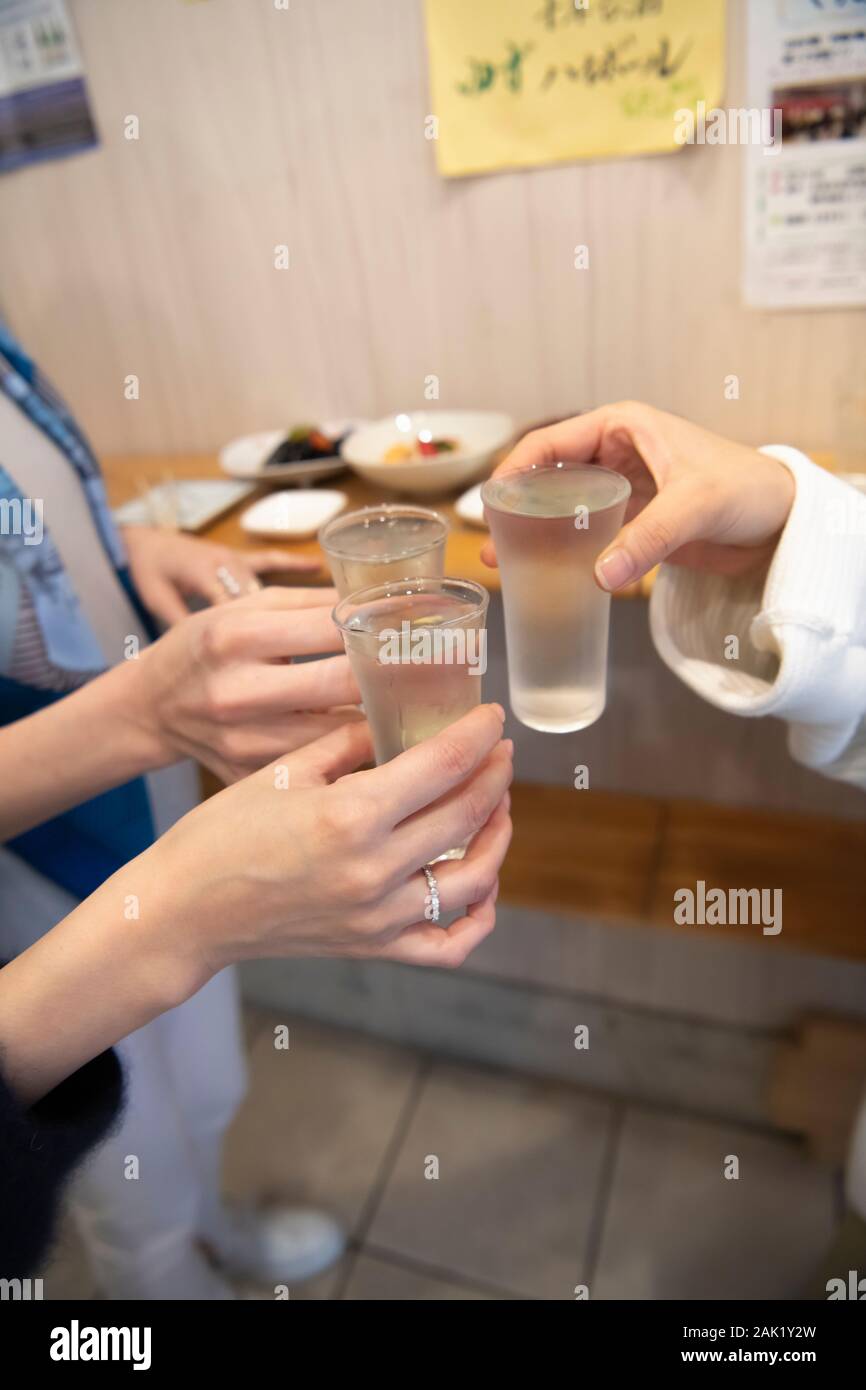 Women drinking Japanese sake in standing bar Stock Photo - Alamy