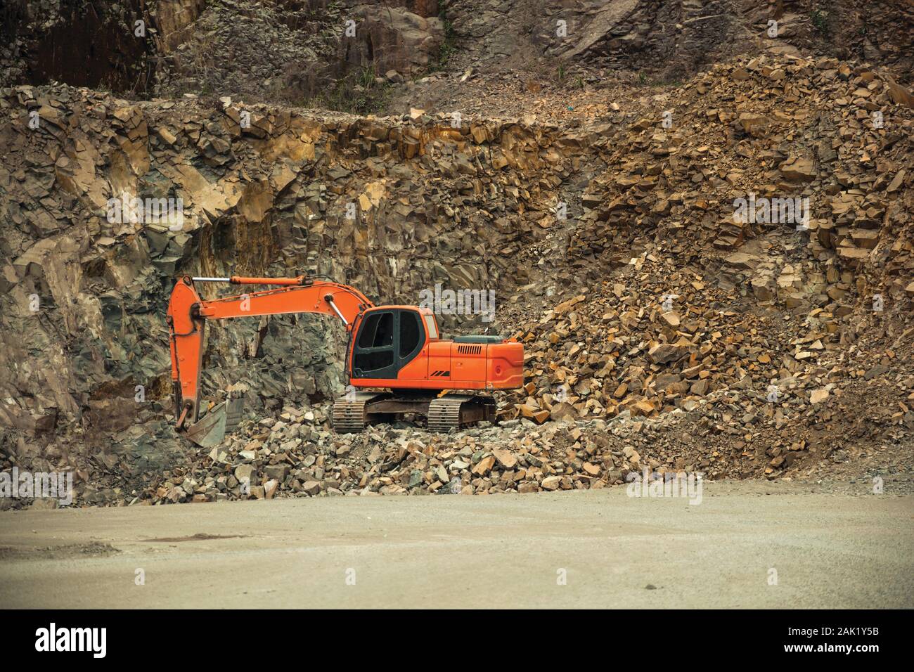 Excavator with stones and rocks in a quarry near Bento Goncalves. A ...