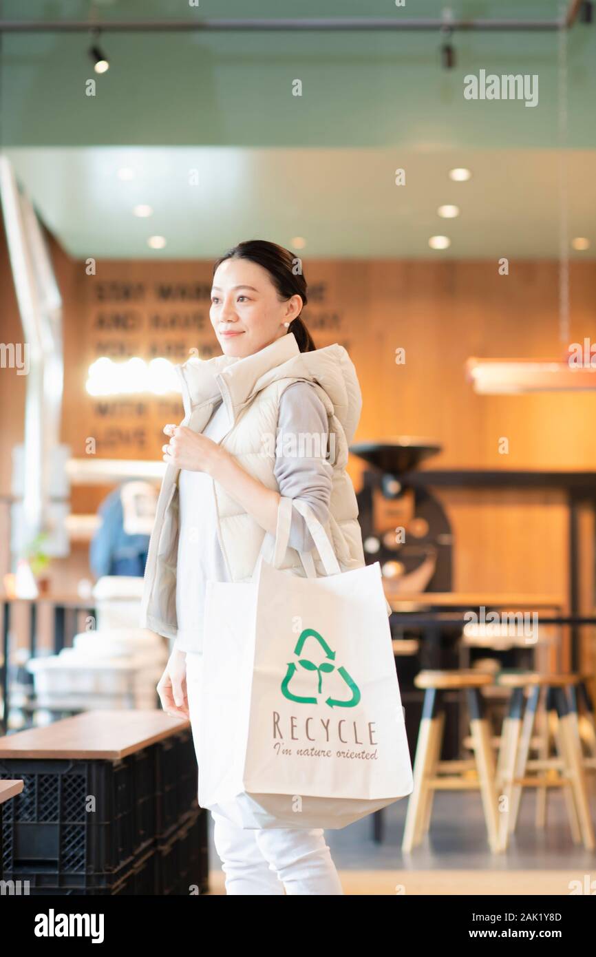 Woman visiting recycle shop Stock Photo - Alamy
