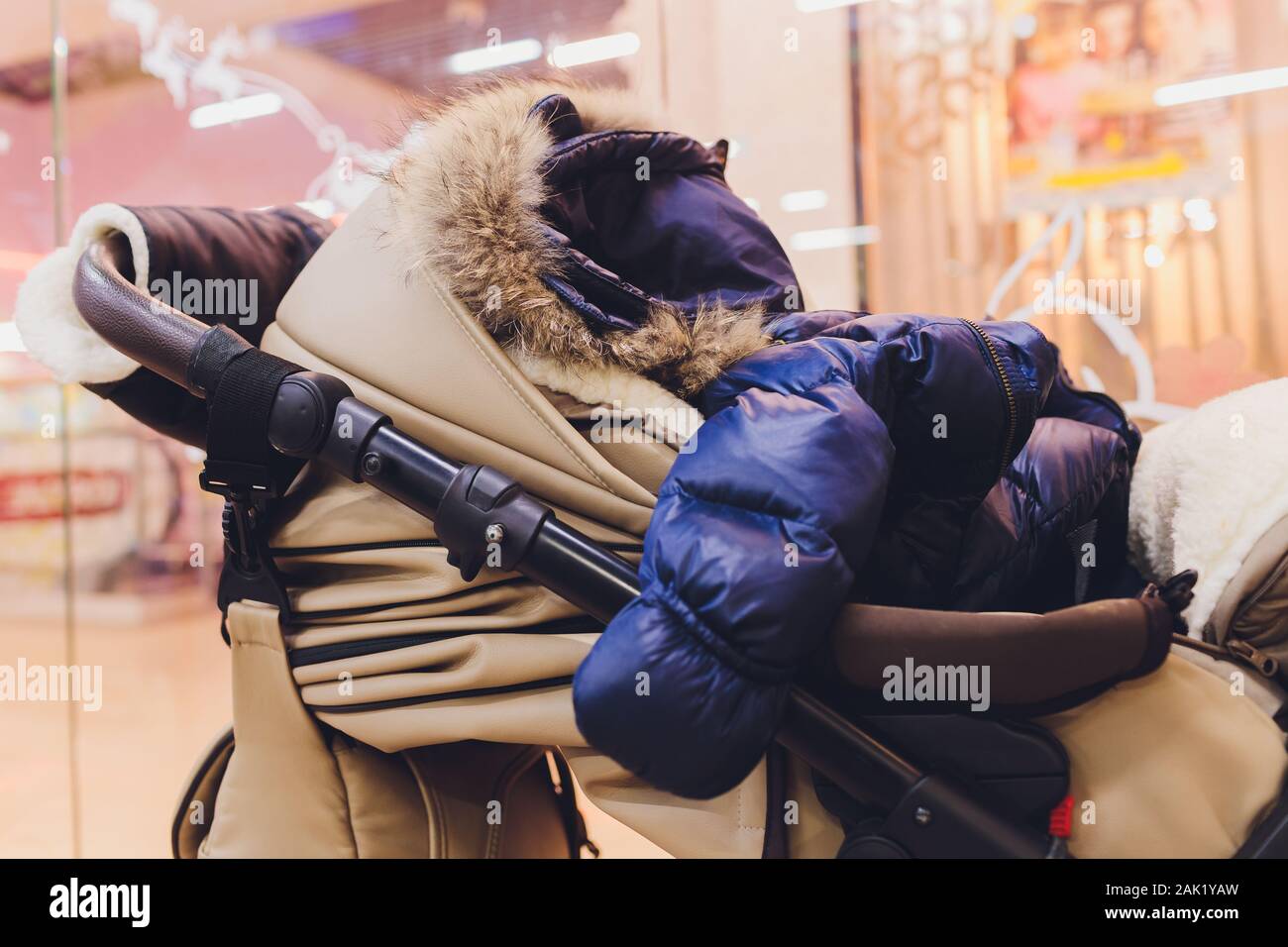 The child sleeps in the stroller. Baby carriage stands on the bank of a ...