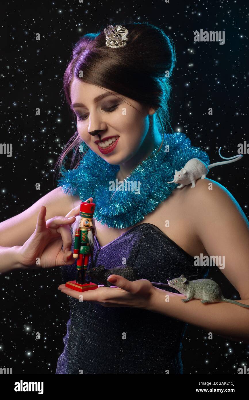 girl in Mouse Queen costume plays with Nutcracker toy on stars ...