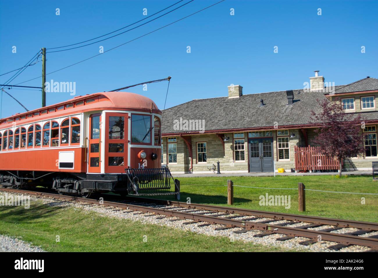 Historic trolley transit train beside train station Stock Photo - Alamy