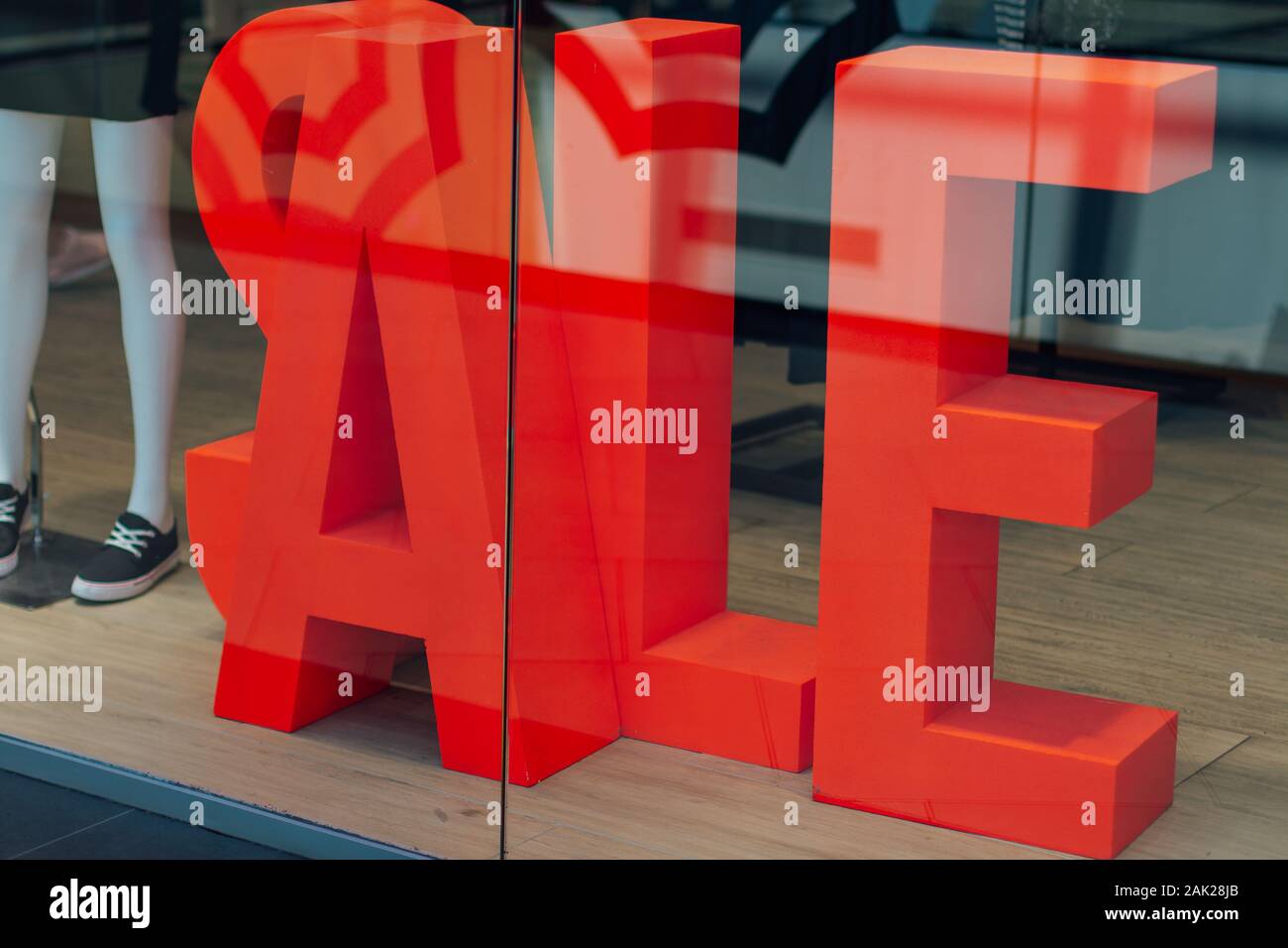 Storefronts with sale sign behind the glass window Stock Photo - Alamy