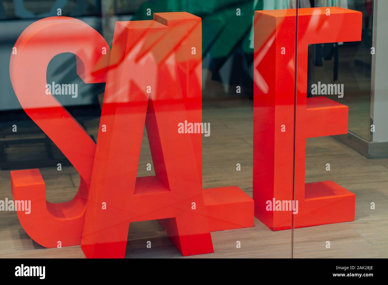 Storefronts with sale sign behind the glass window Stock Photo - Alamy