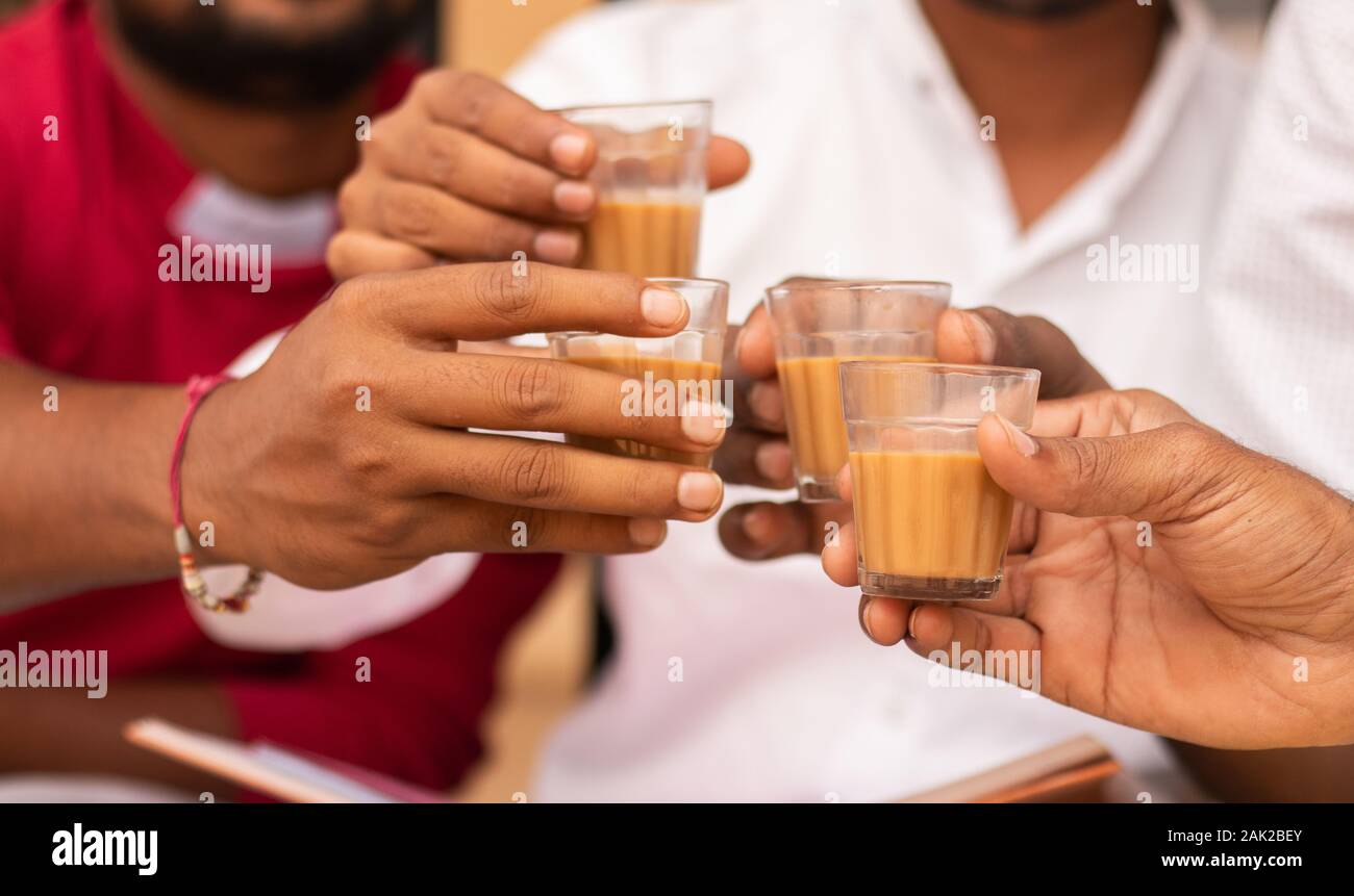 Close up of hands cheers Tea glasses - concept showing group of friends ...