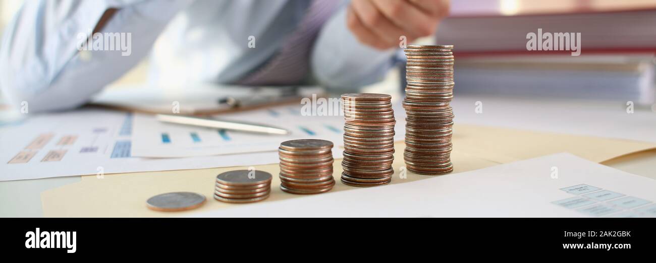 Hand businessman putting pin money Stock Photo - Alamy