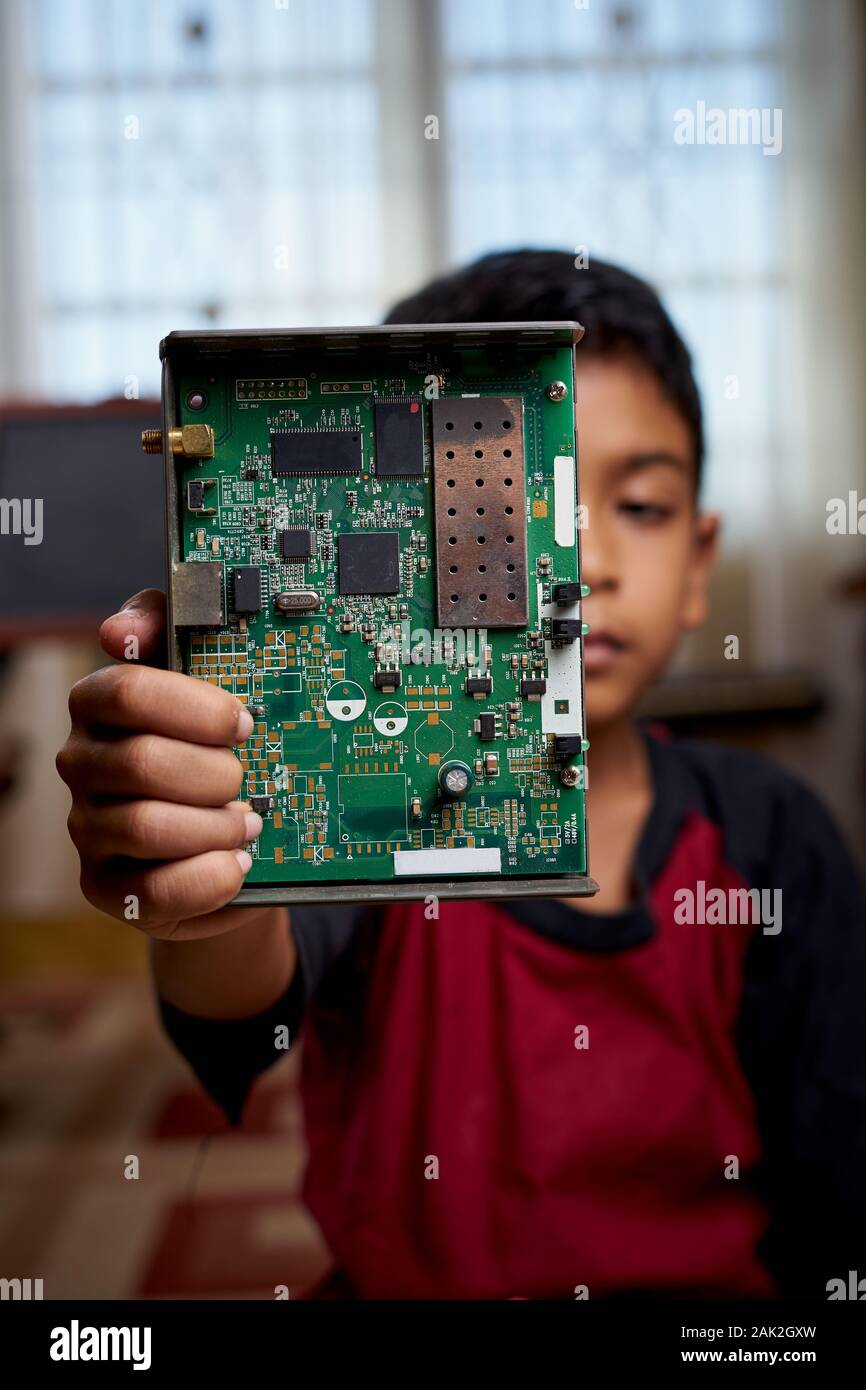 Smart Asian Boy working on Electronic Circuitry at home Stock Photo - Alamy