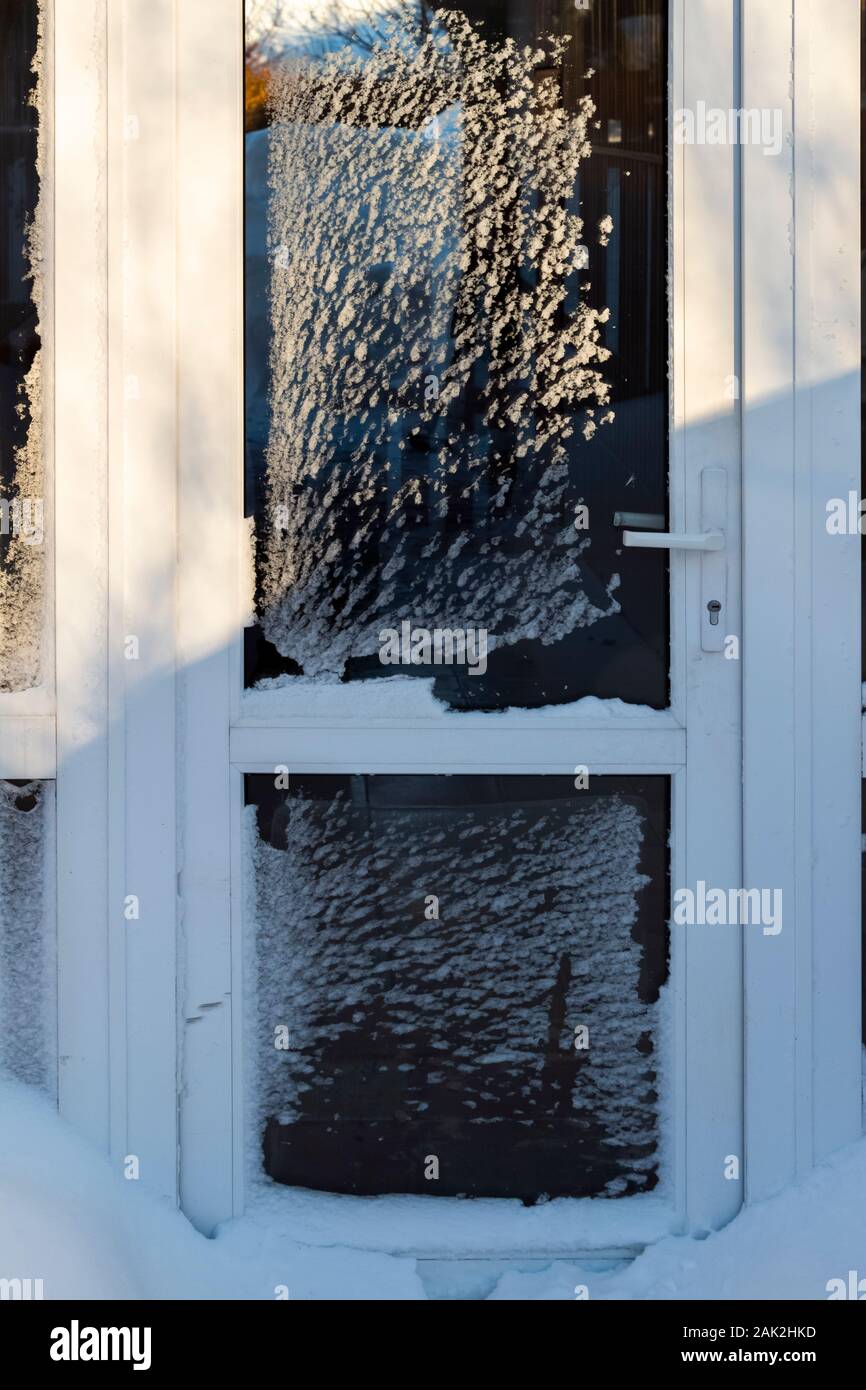 The white front door is covered with snow after a blizzard Stock Photo ...