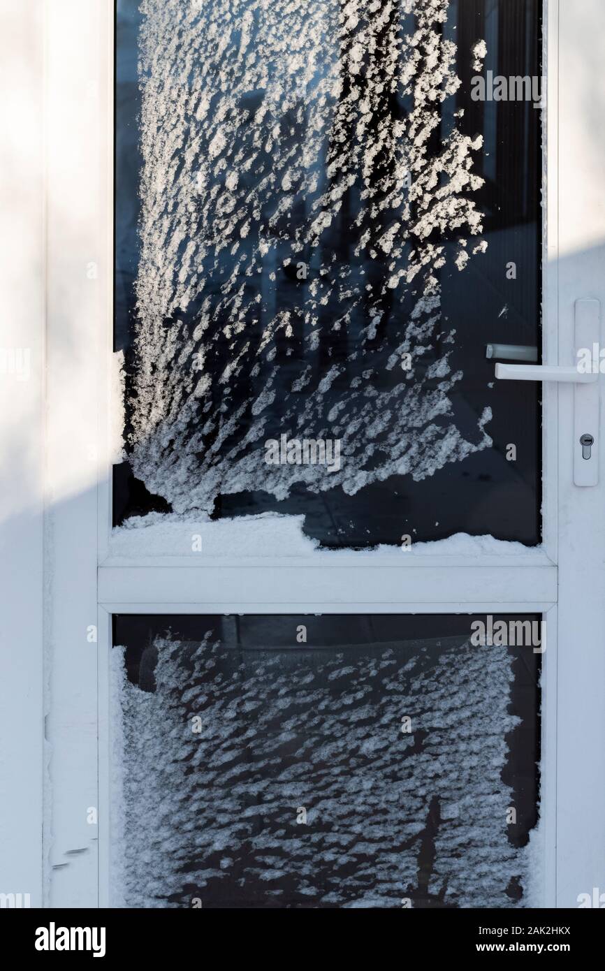 The white front door is covered with snow after a blizzard Stock Photo ...