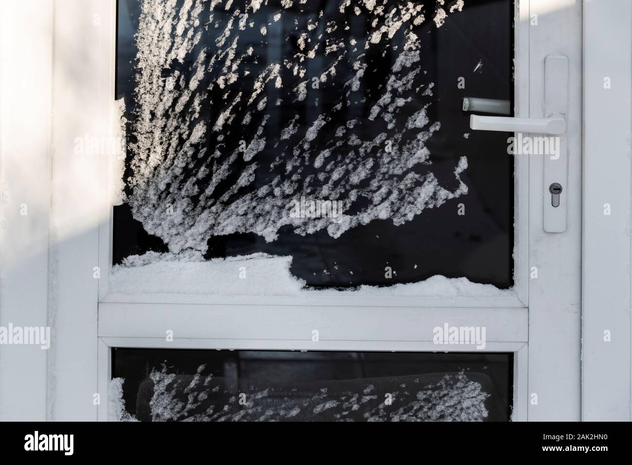 The white front door is covered with snow after a blizzard Stock Photo ...