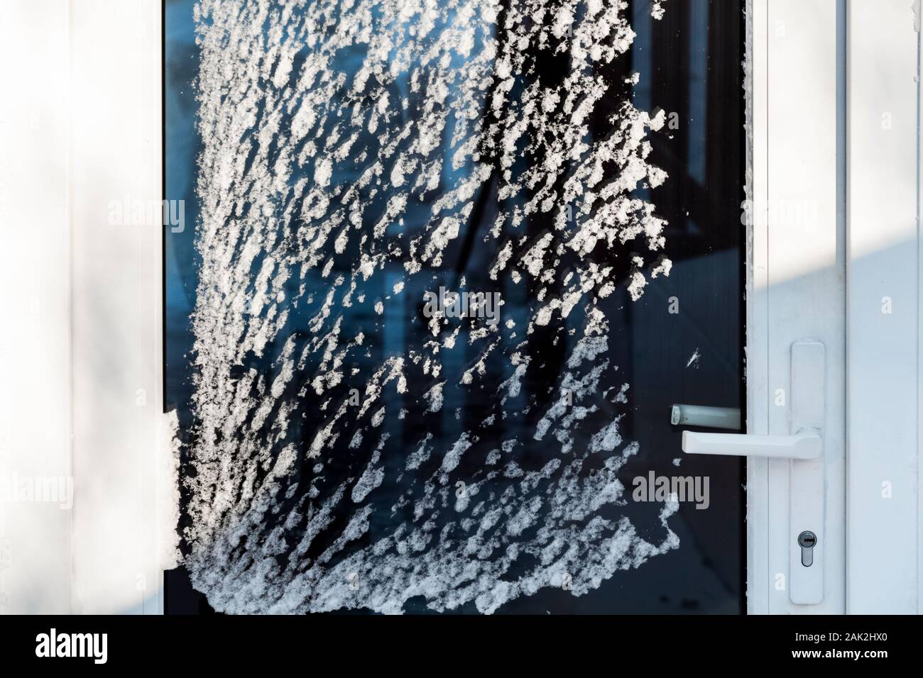 The white front door is covered with snow after a blizzard Stock Photo ...