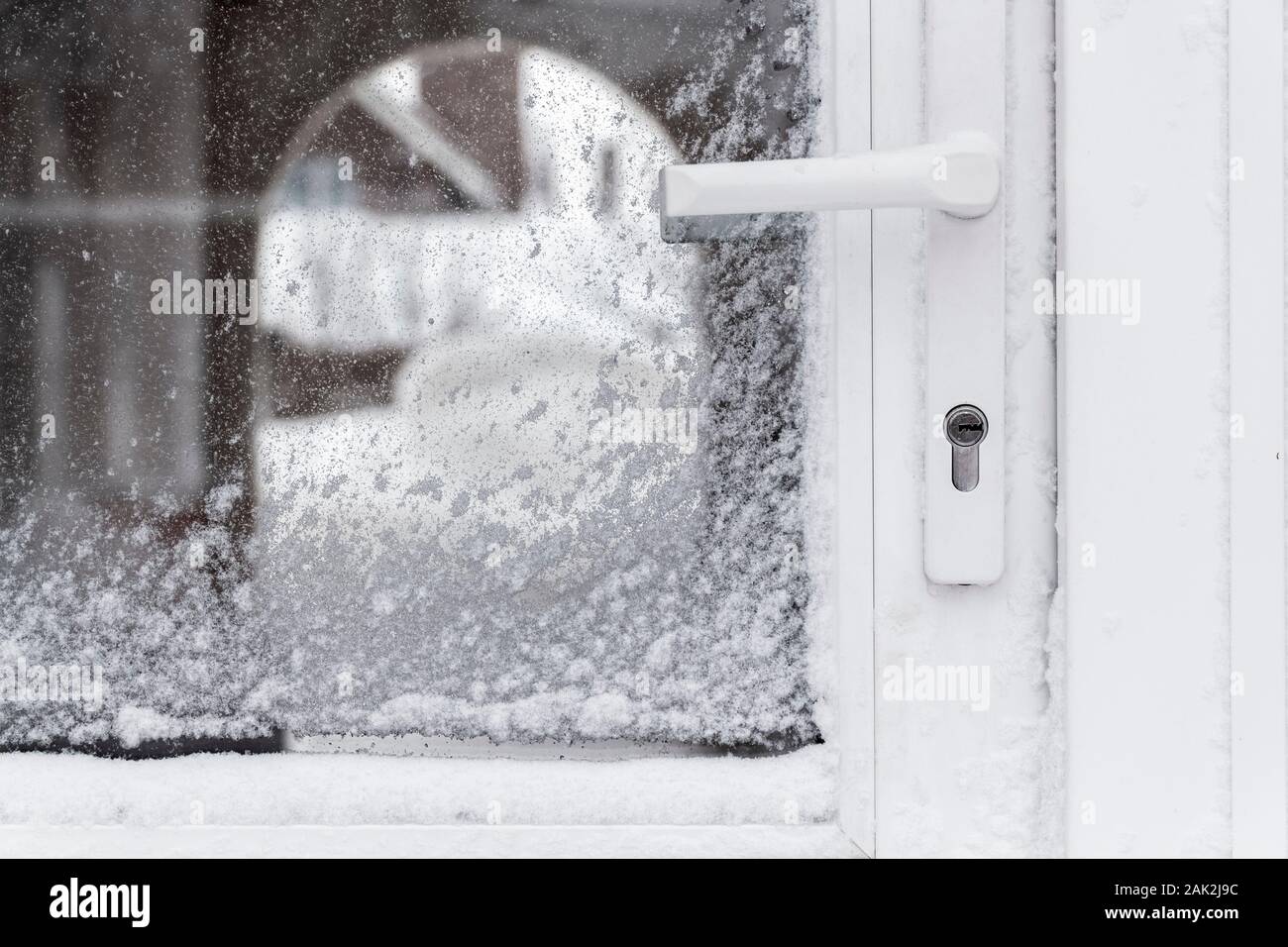 The white front door is covered with snow after a blizzard Stock Photo ...