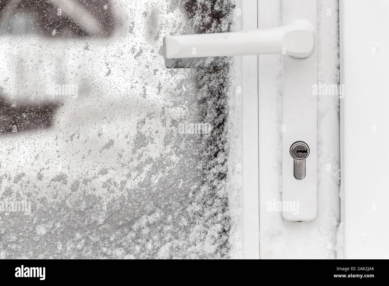 The white front door is covered with snow after a blizzard Stock Photo ...