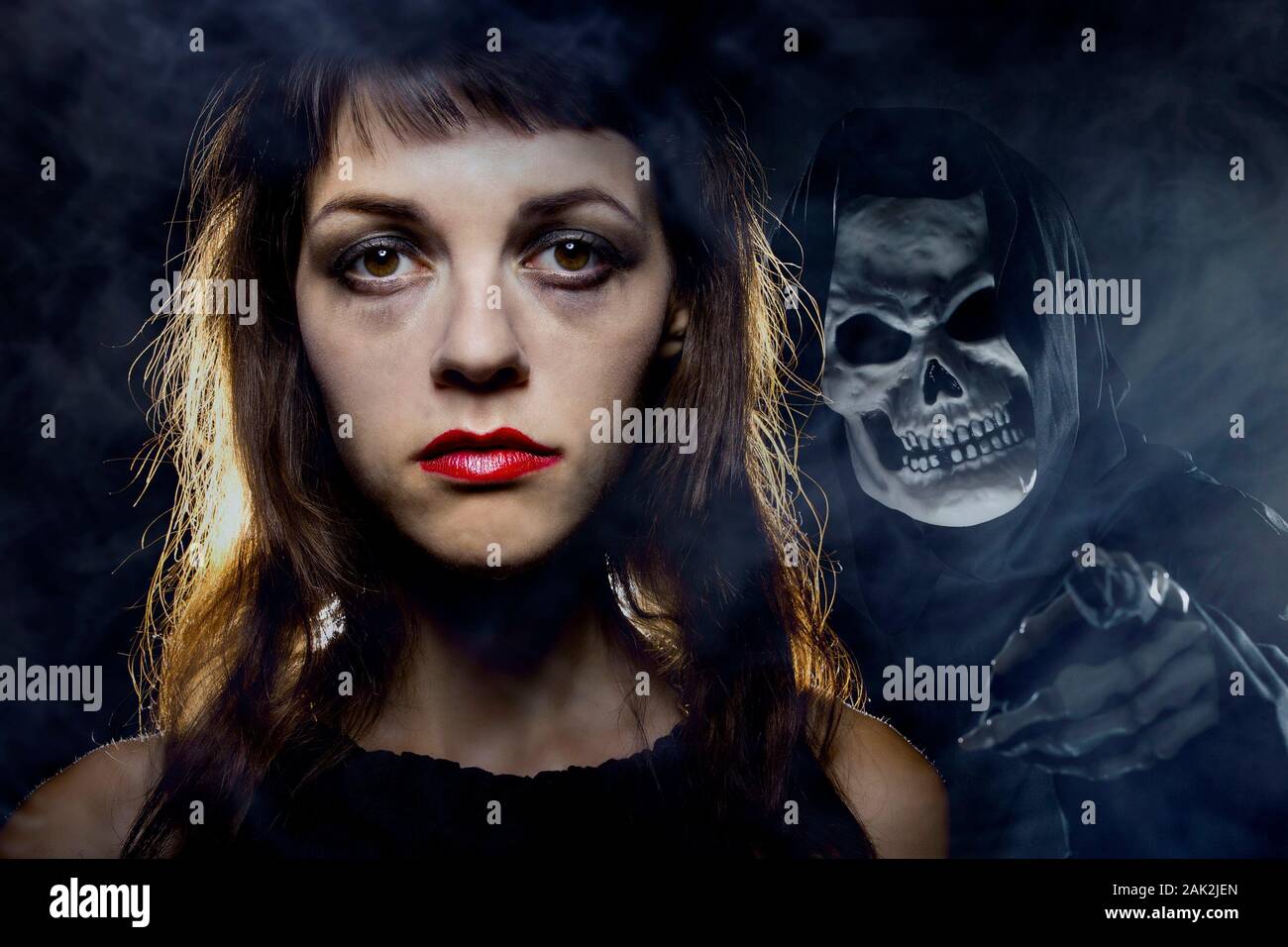 Woman in a dark alley with fog or mist imagining or seeing a demon or ...