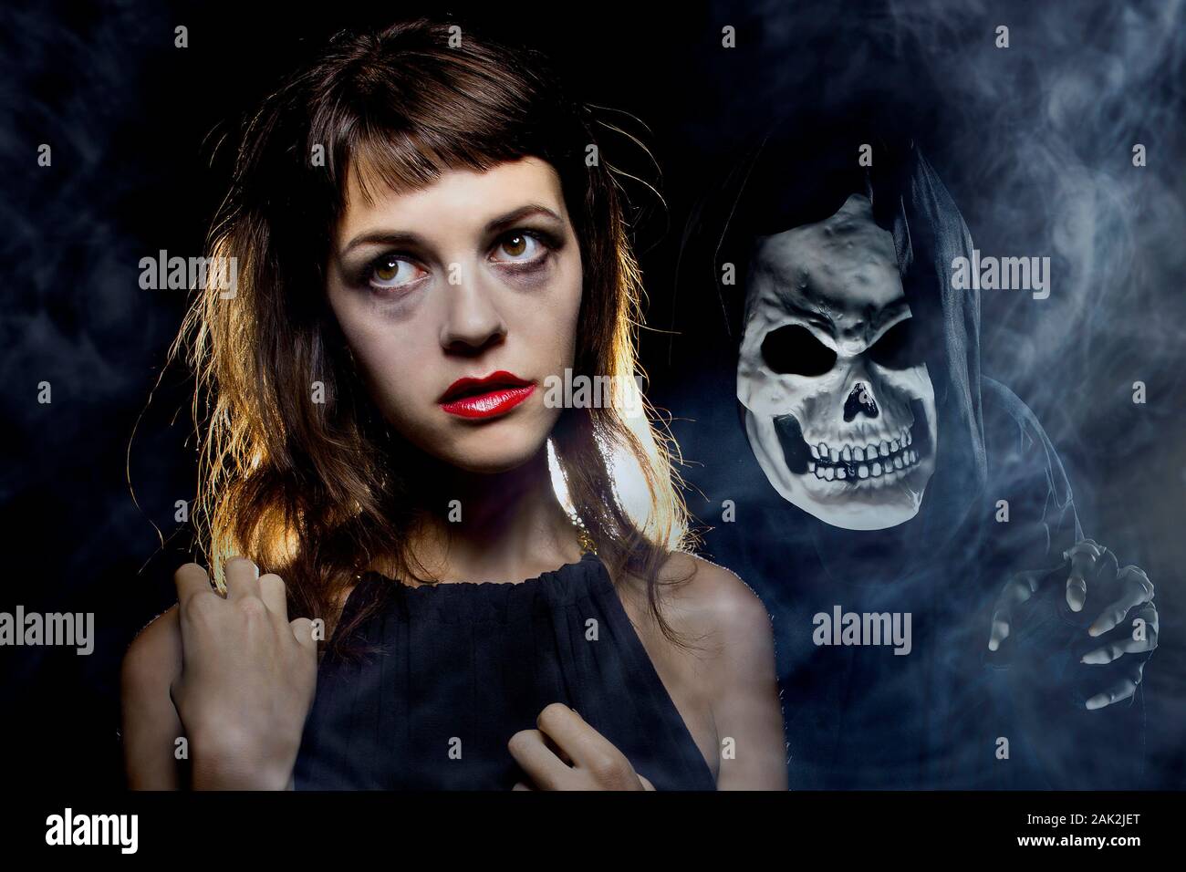 Woman in a dark alley with fog or mist imagining or seeing a demon or ...