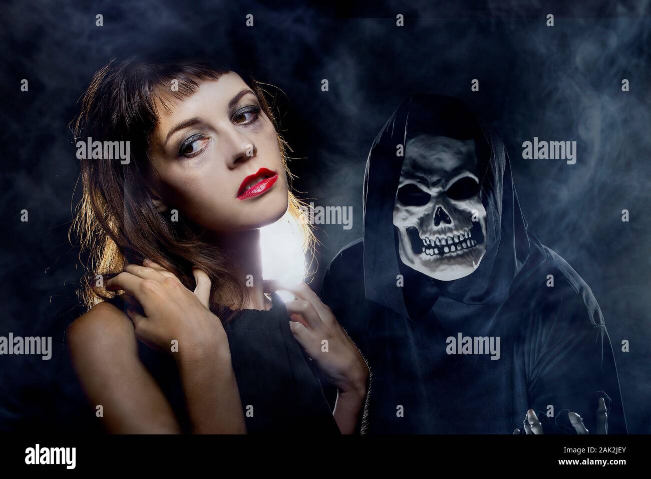 Woman in a dark alley with fog or mist imagining or seeing a demon or ...