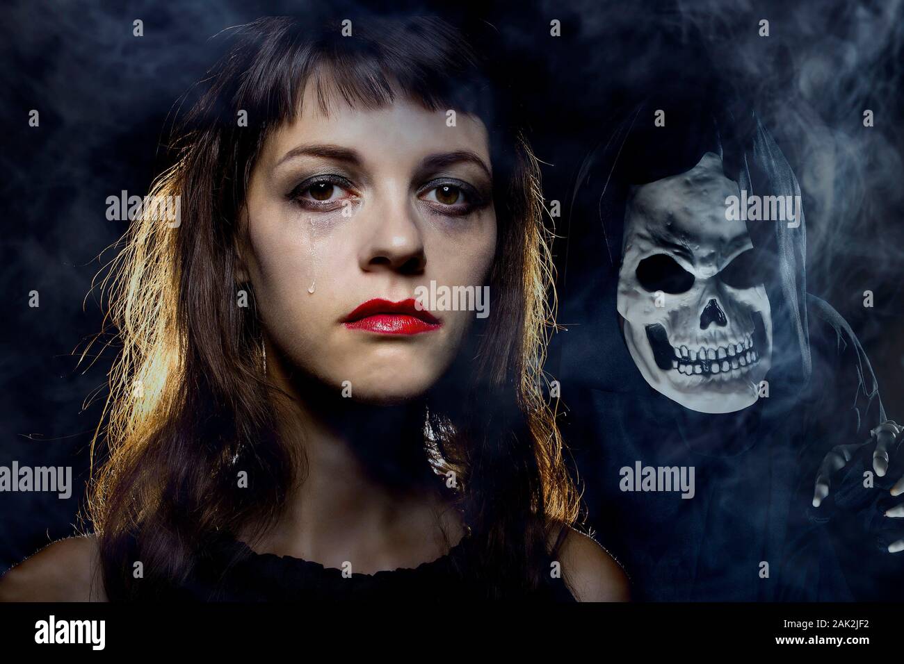 Woman in a dark alley with fog or mist imagining or seeing a demon or ...