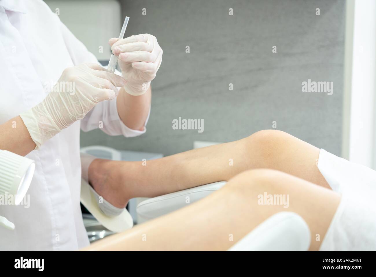 Gynecologist with syringe makes an injection to patient in gynecology ...