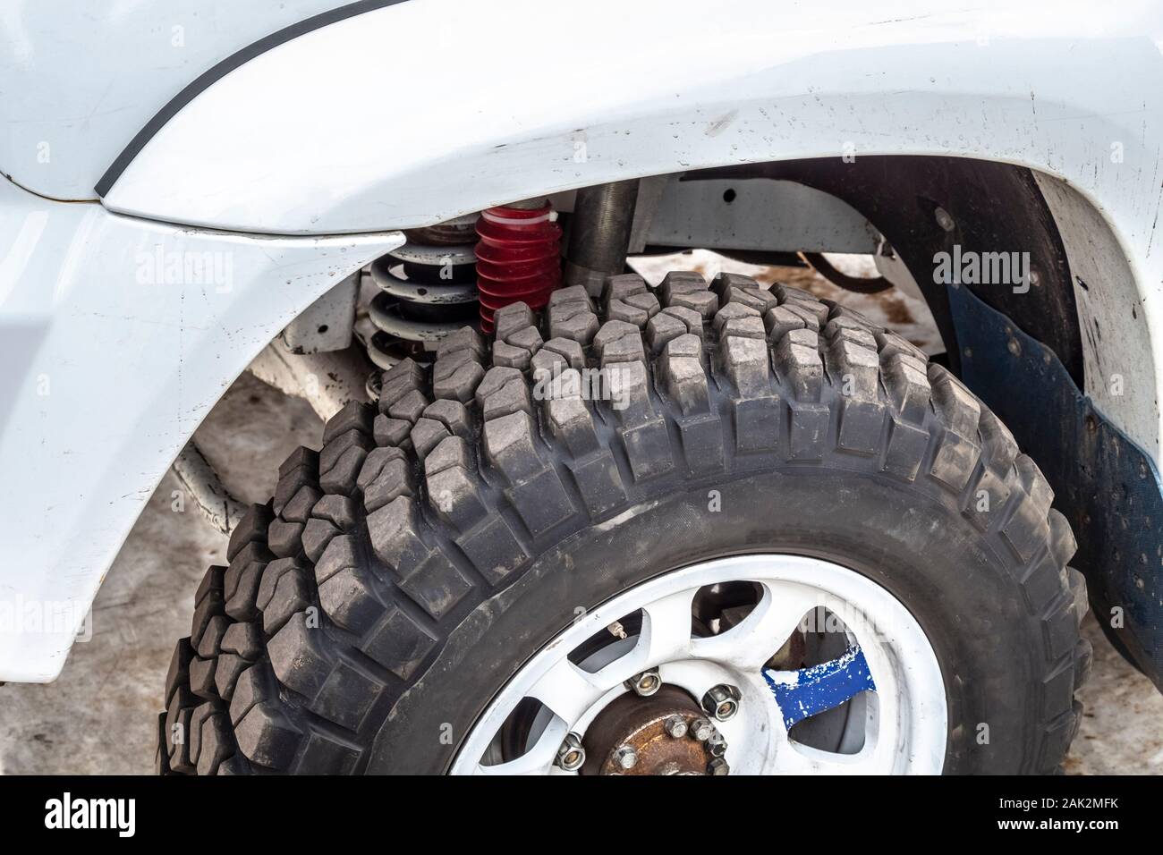 Wheel of white offroad pickup truck close-up Stock Photo - Alamy