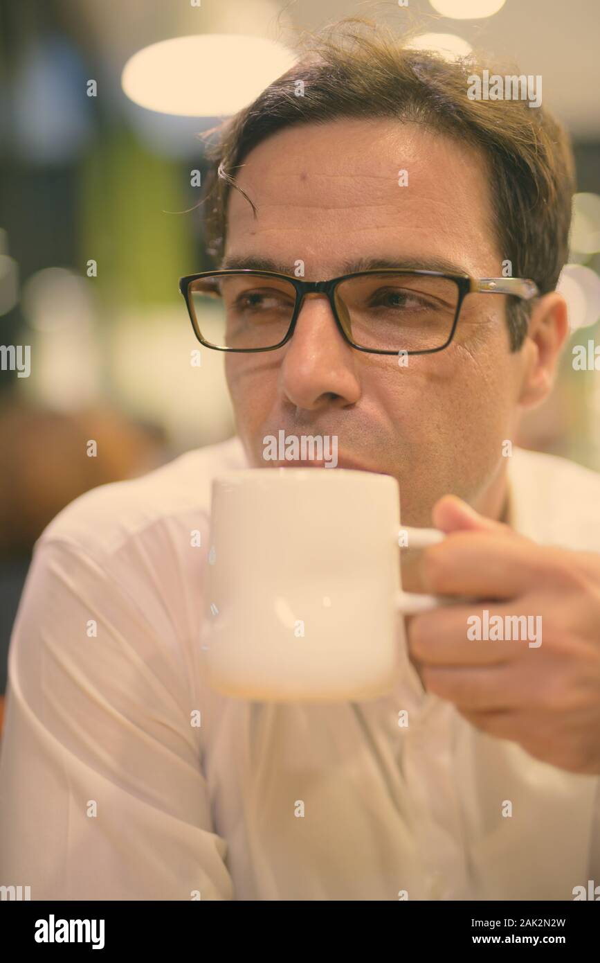 Handsome Persian businessman relaxing at the coffee shop Stock Photo ...