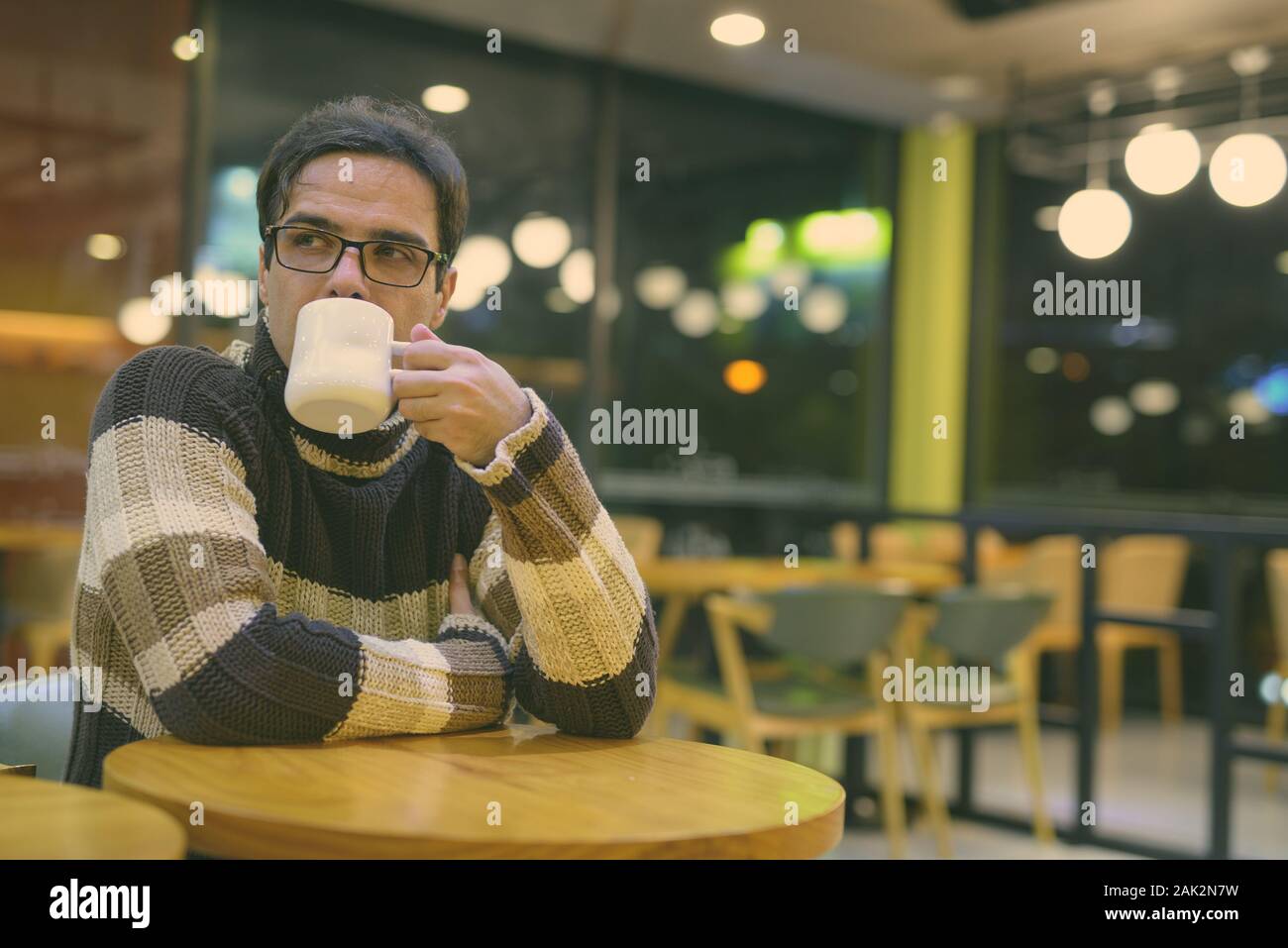 Handsome Persian man relaxing at the coffee shop Stock Photo - Alamy