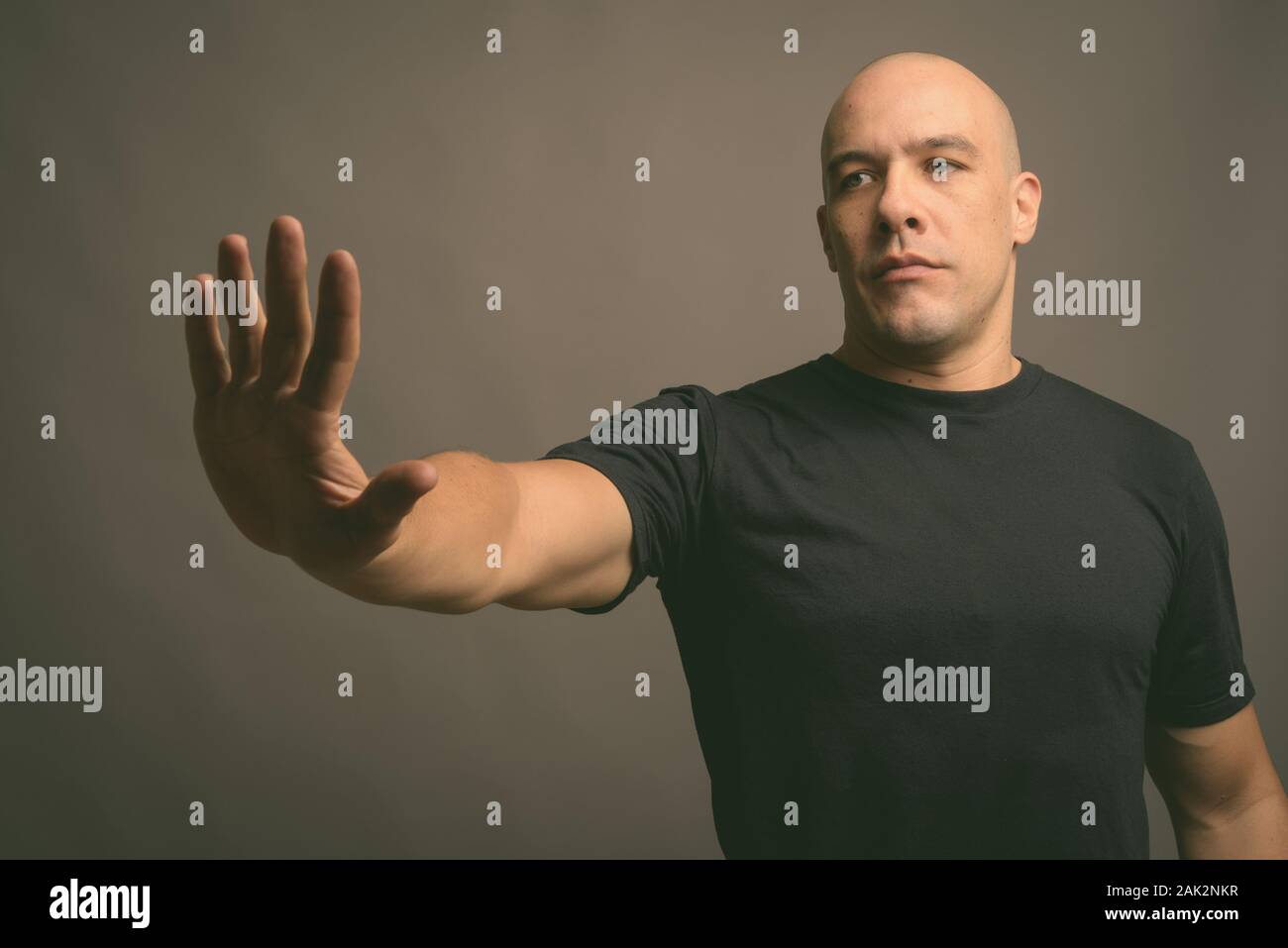 Portrait of handsome bald man against gray background Stock Photo - Alamy