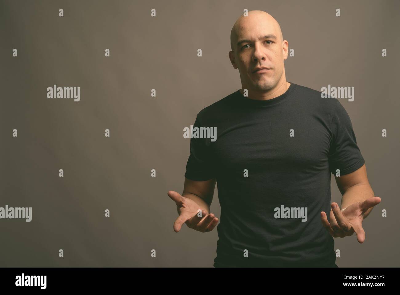 Portrait of handsome bald man against gray background Stock Photo - Alamy