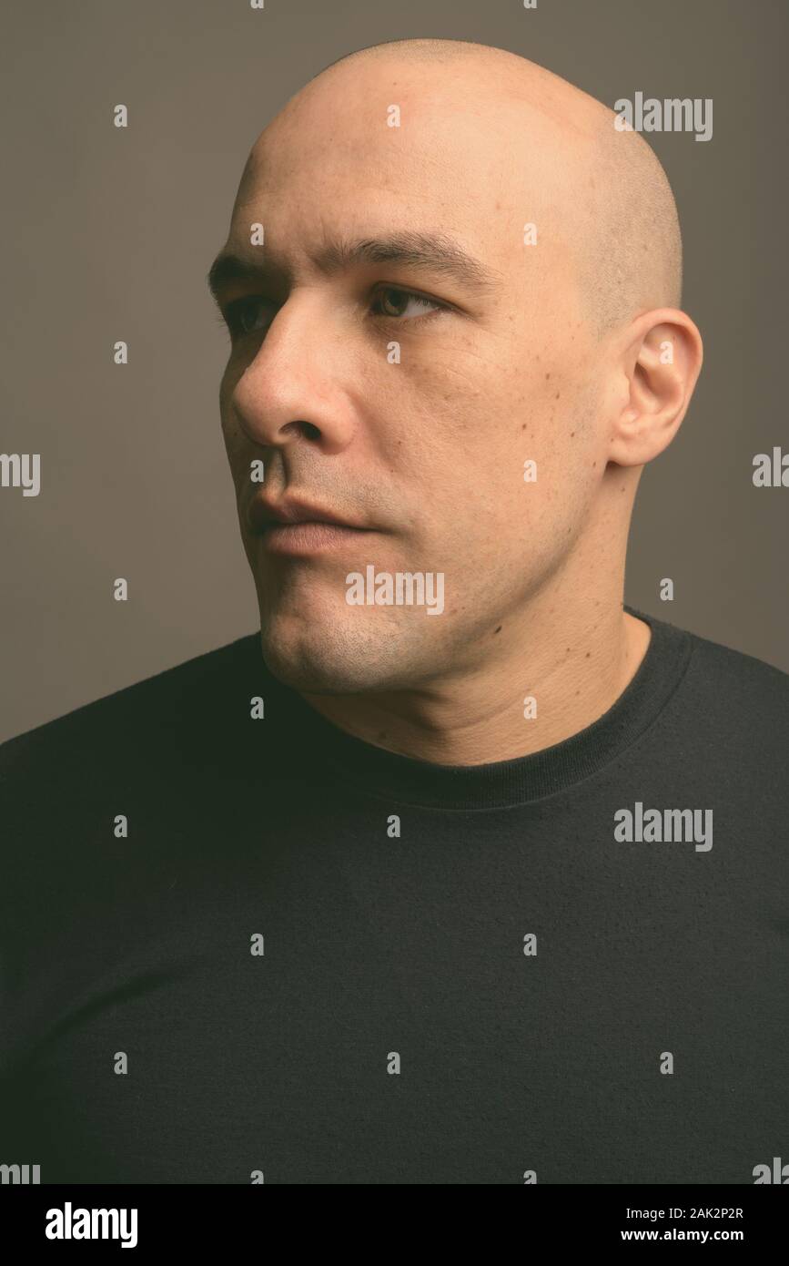 Portrait of handsome bald man against gray background Stock Photo - Alamy