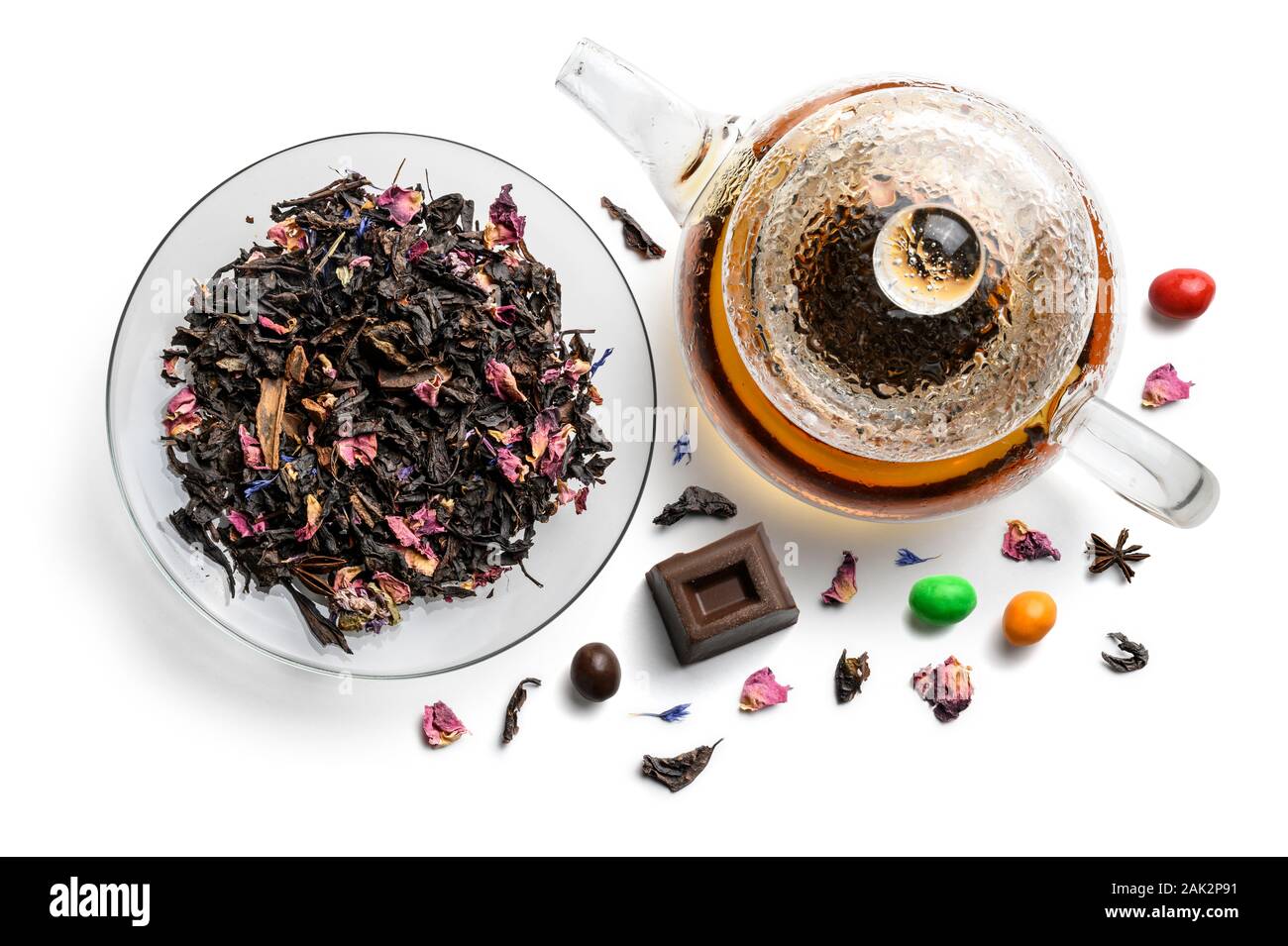 Black tea with natural flavors and a teapot. Top view on white ...