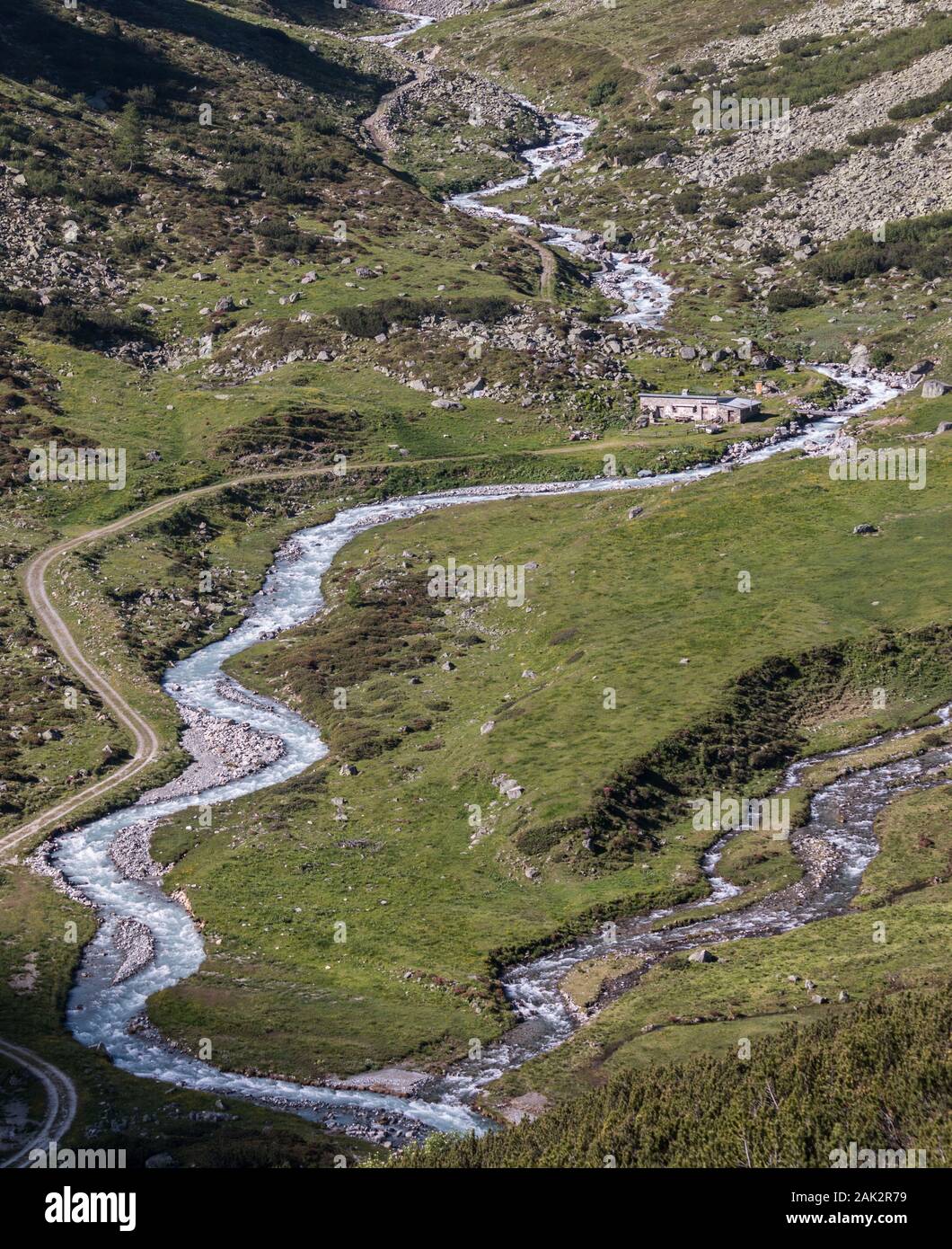 A beautiful alpine river fast flowing from winter snow melt Stock Photo ...