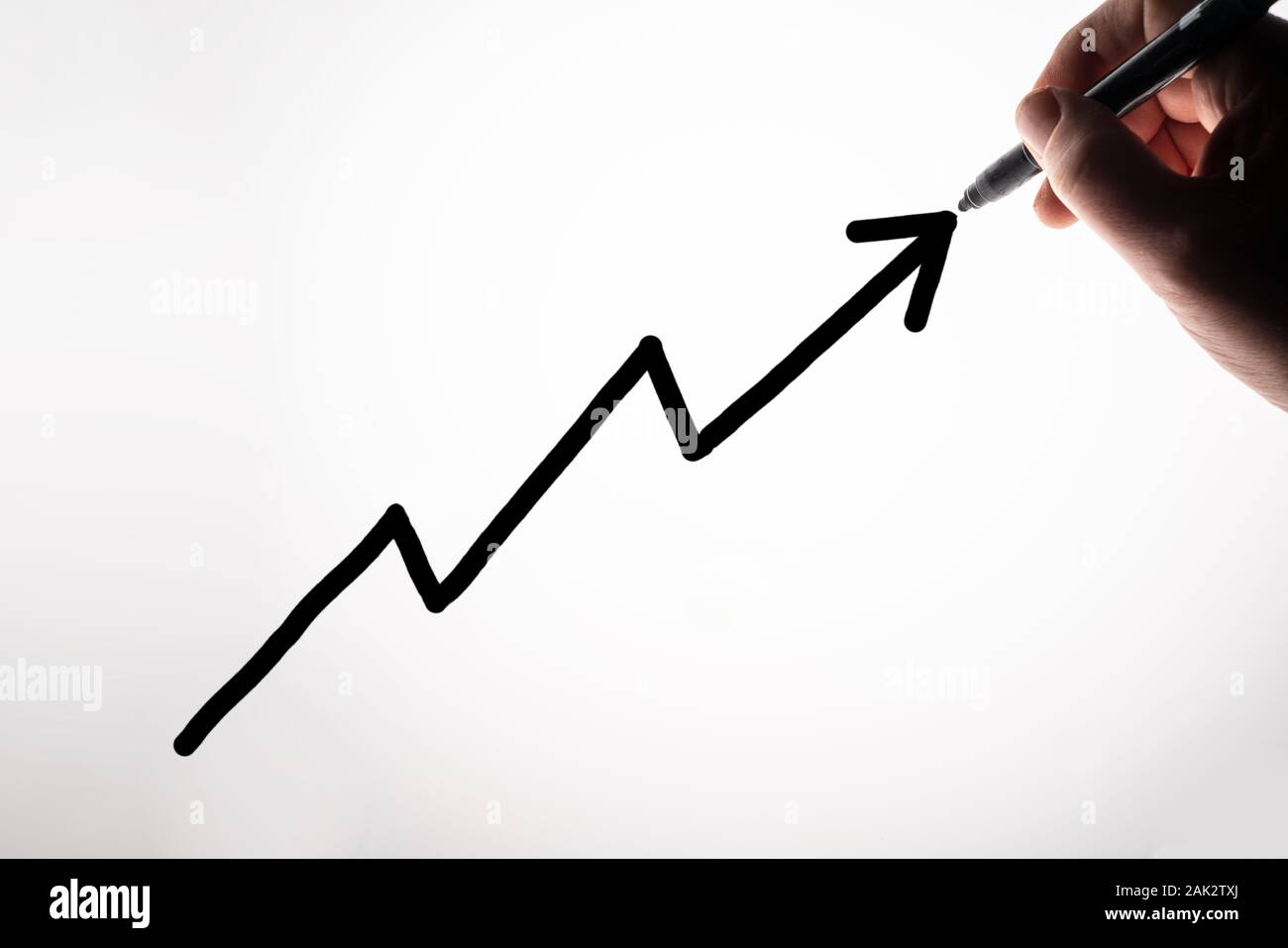 the trend graph drawn on a backlit surface Stock Photo - Alamy