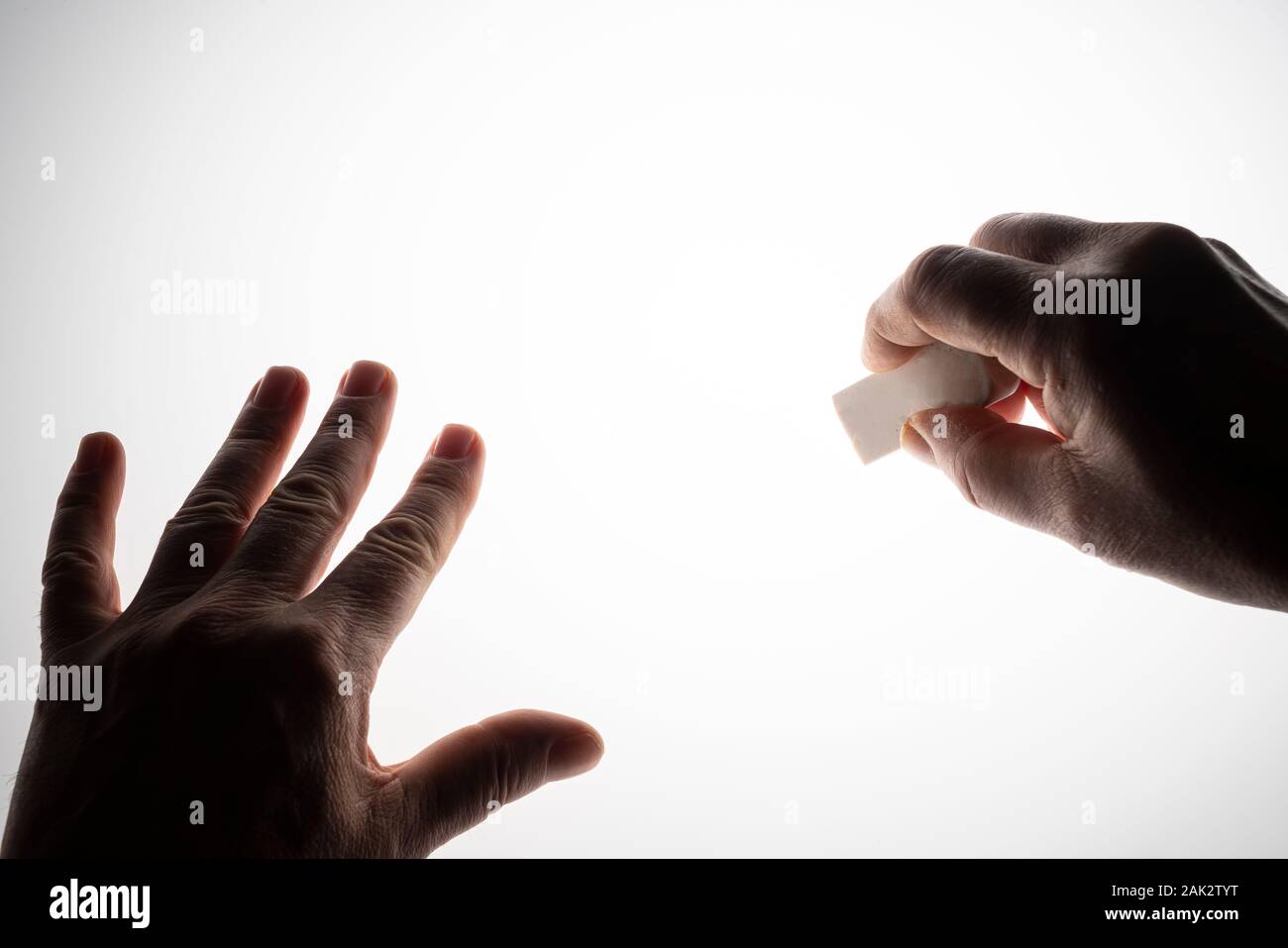 the gesture of erasing with an eraser on a backlit surface Stock Photo ...