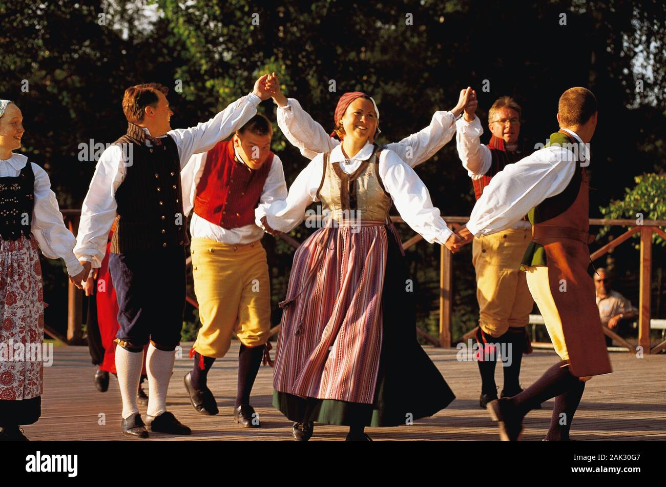 A group, dressed in old Swedish costumes, performs a traditional dance ...
