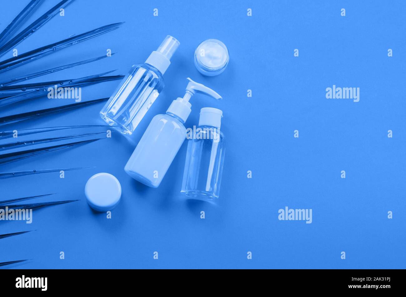 Generic beauty products on classic blue background Stock Photo - Alamy