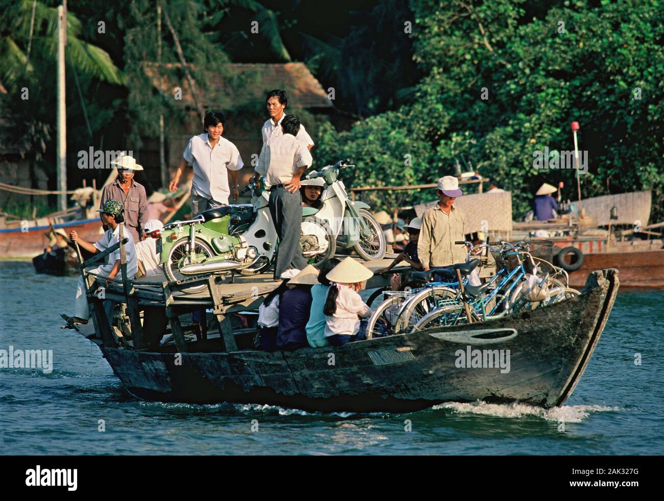 A totally overloaded ferry ferries accross a river in Vietnam. (Undated ...