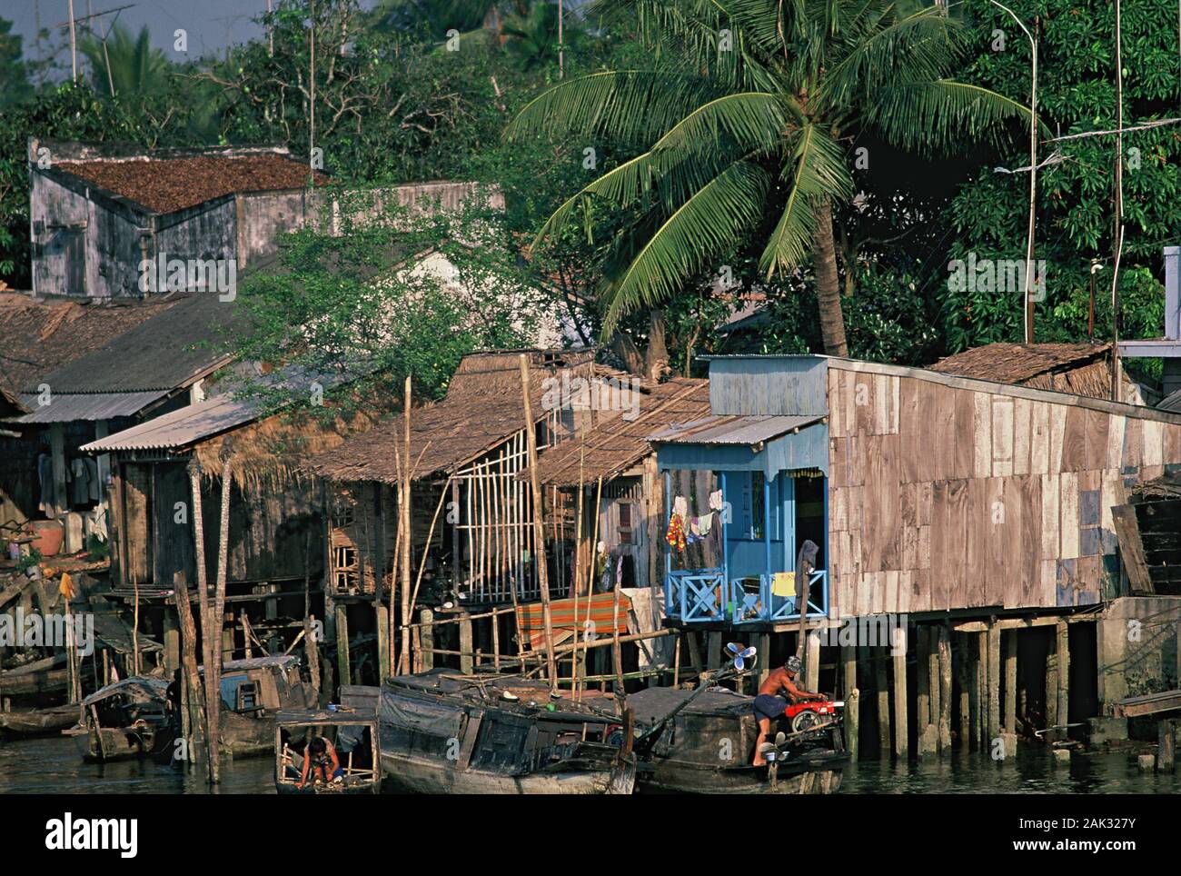 Simple barracks, partly built on stilts in the river, are situated in ...