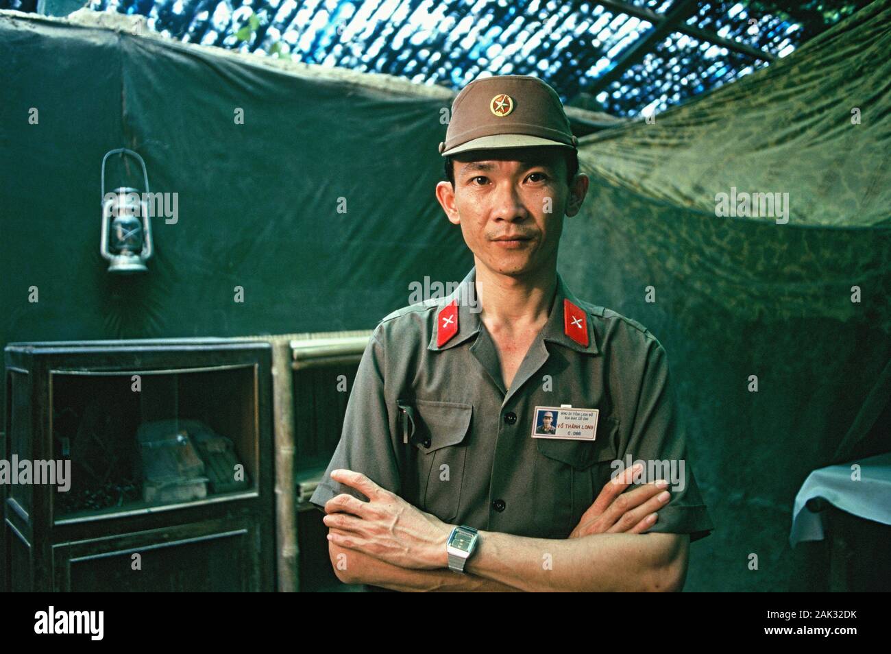 A Vietnamese soldier standing at the tunnel of Cu Chi in the south of ...