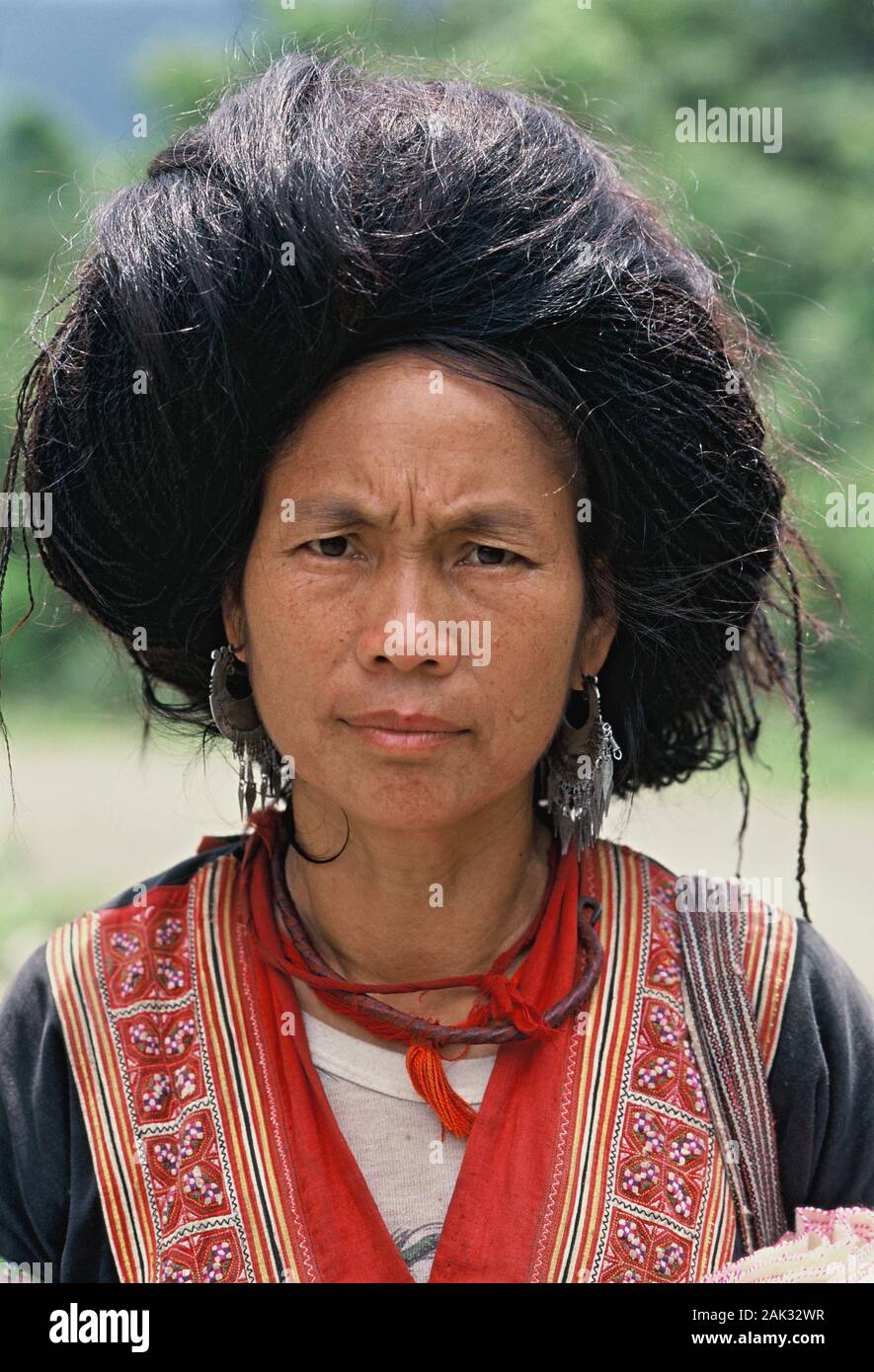 A woman of the Meo people in the north of Vietnam looking seriously in ...