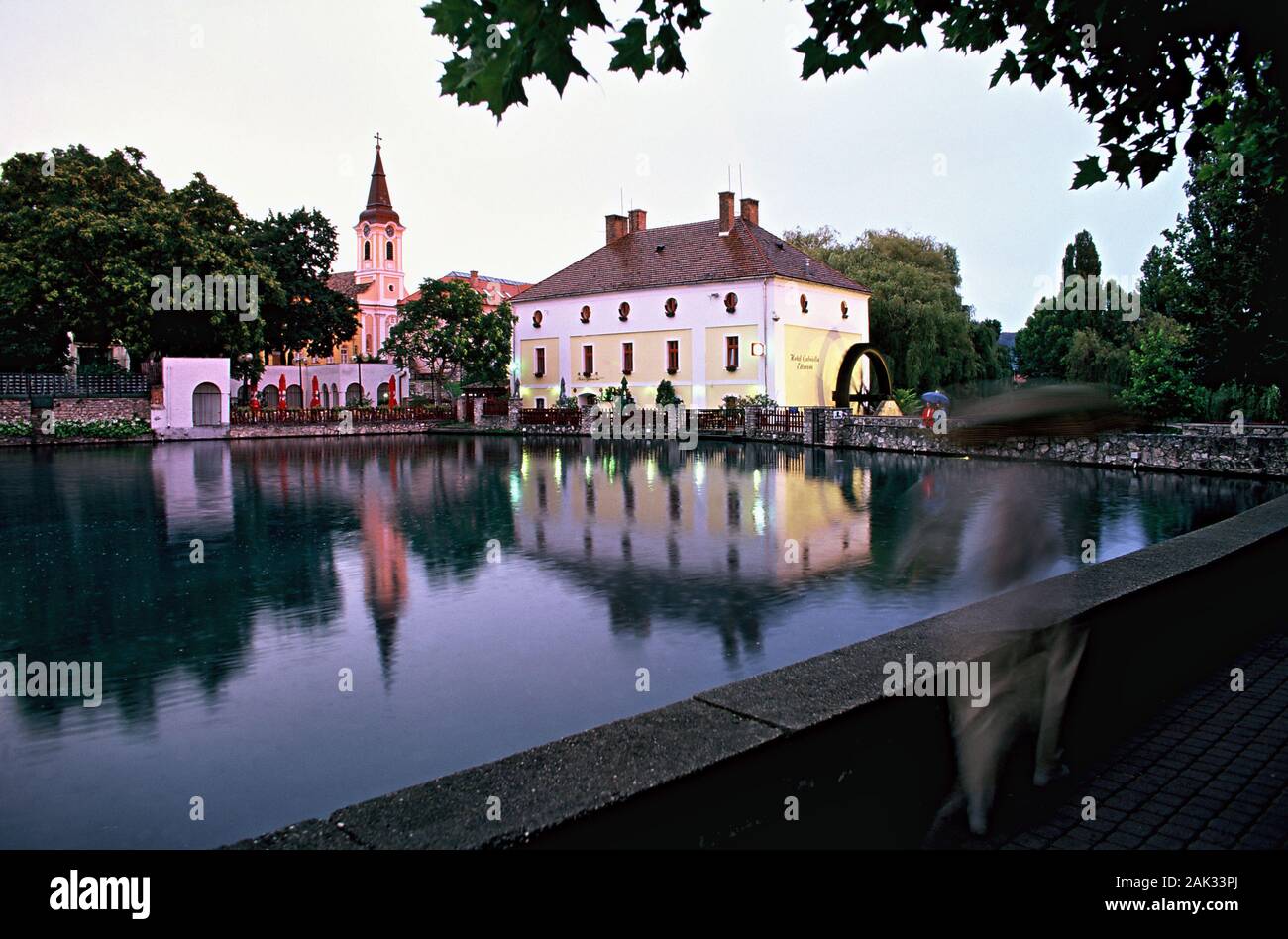 View of Lake Malom and the former mill, which serves as a hotel today ...