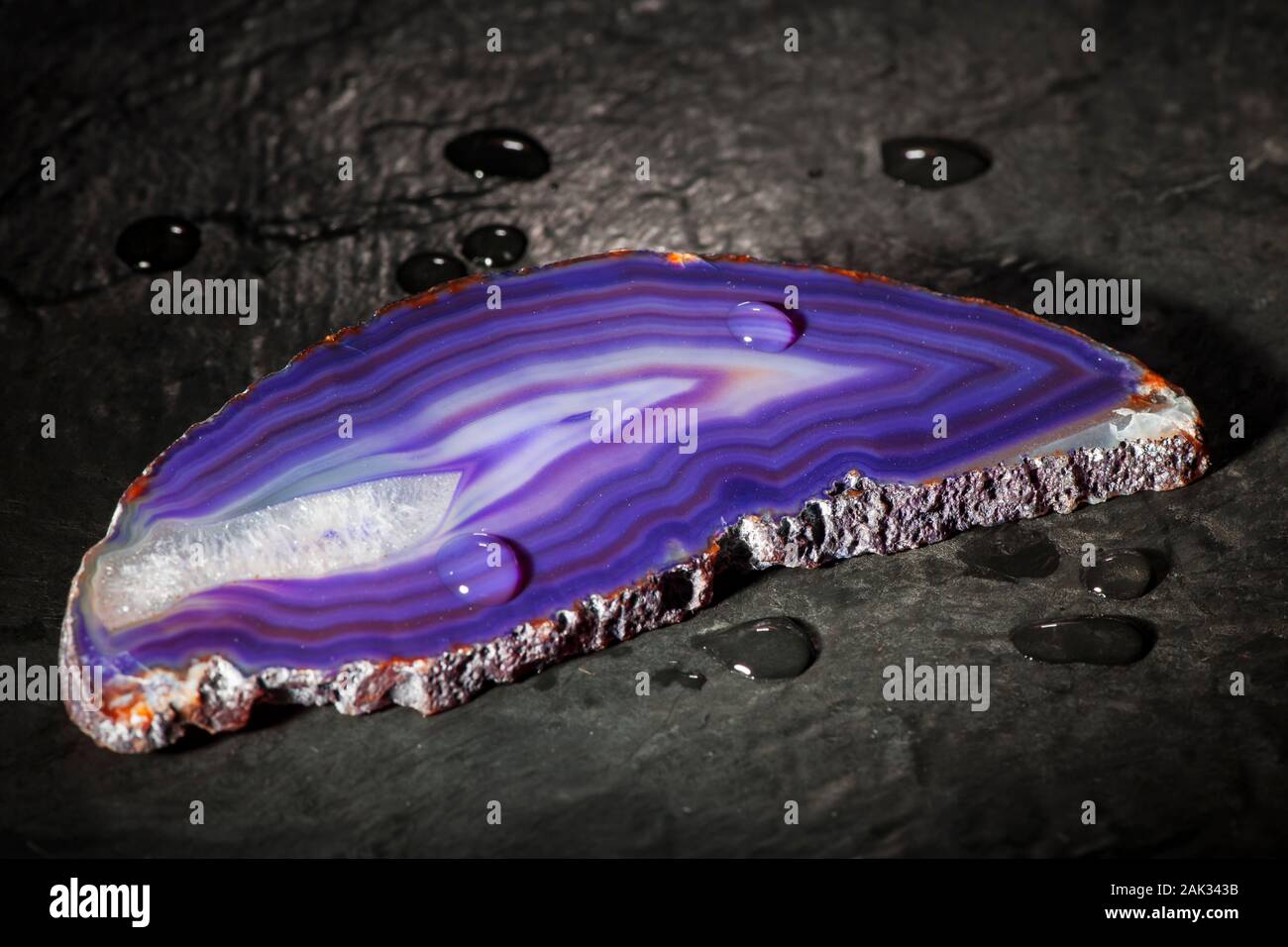 Close-up of an elongated flat polished agate slice with blue irregular ...