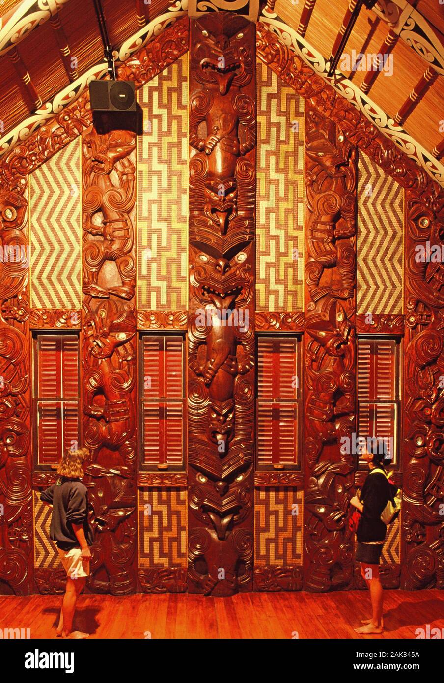 Visitors regarding the skillful carvings in the Waitangi House, the ...