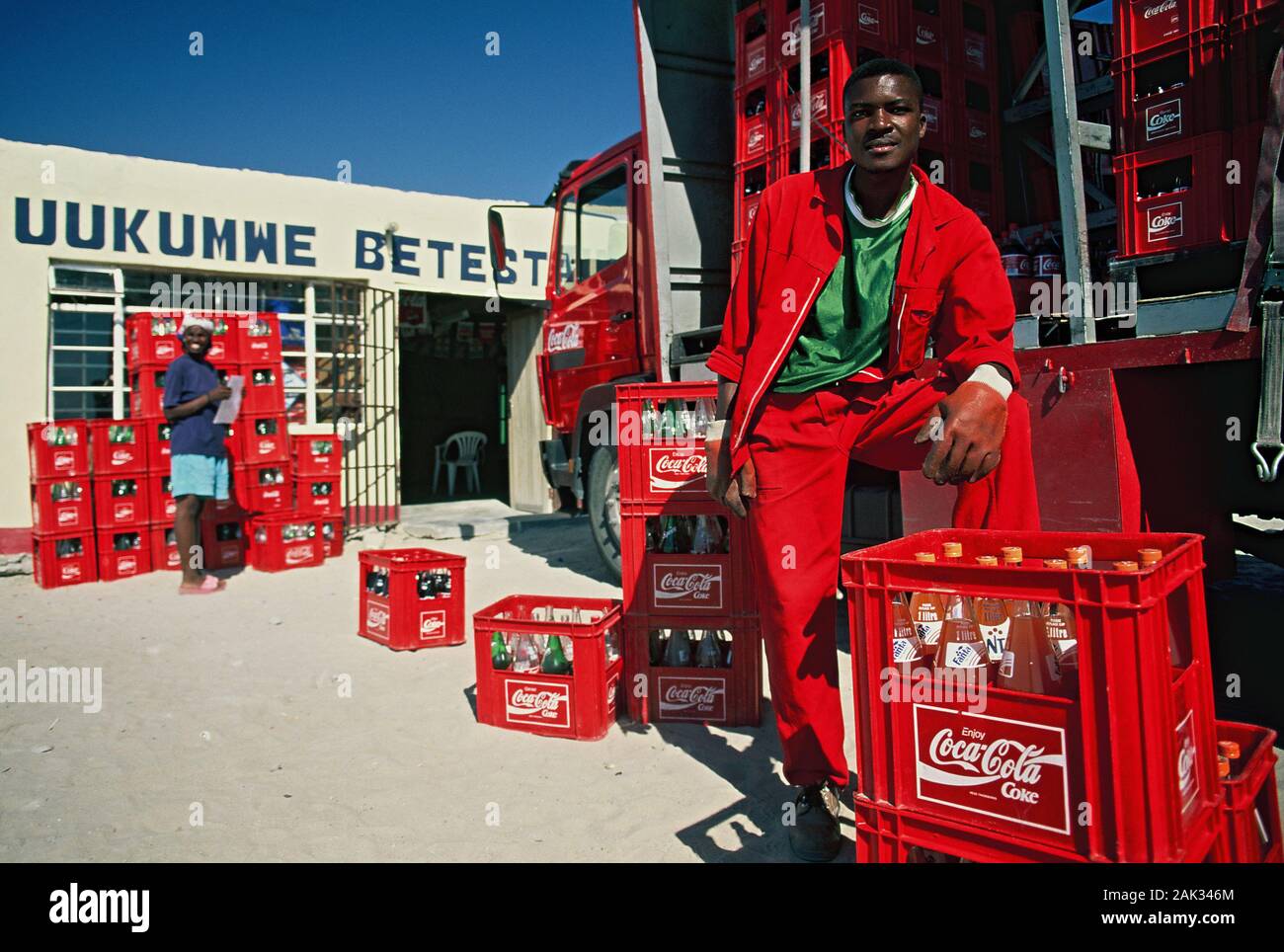 A man at work in front of a market for beverages in Ondagwa, Namibia ...