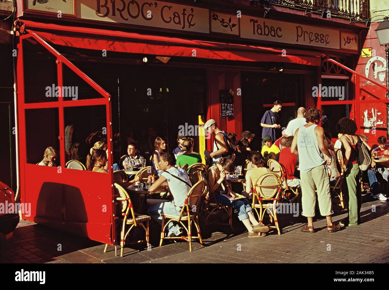 Young people sit in front of a cafe, the Broc Cafe, in Caen in the ...
