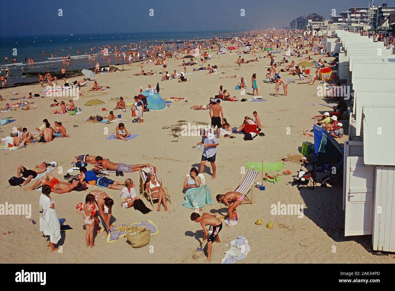 People swim and sun at the beach of Courseulles-sur-Mer in the Calvados ...