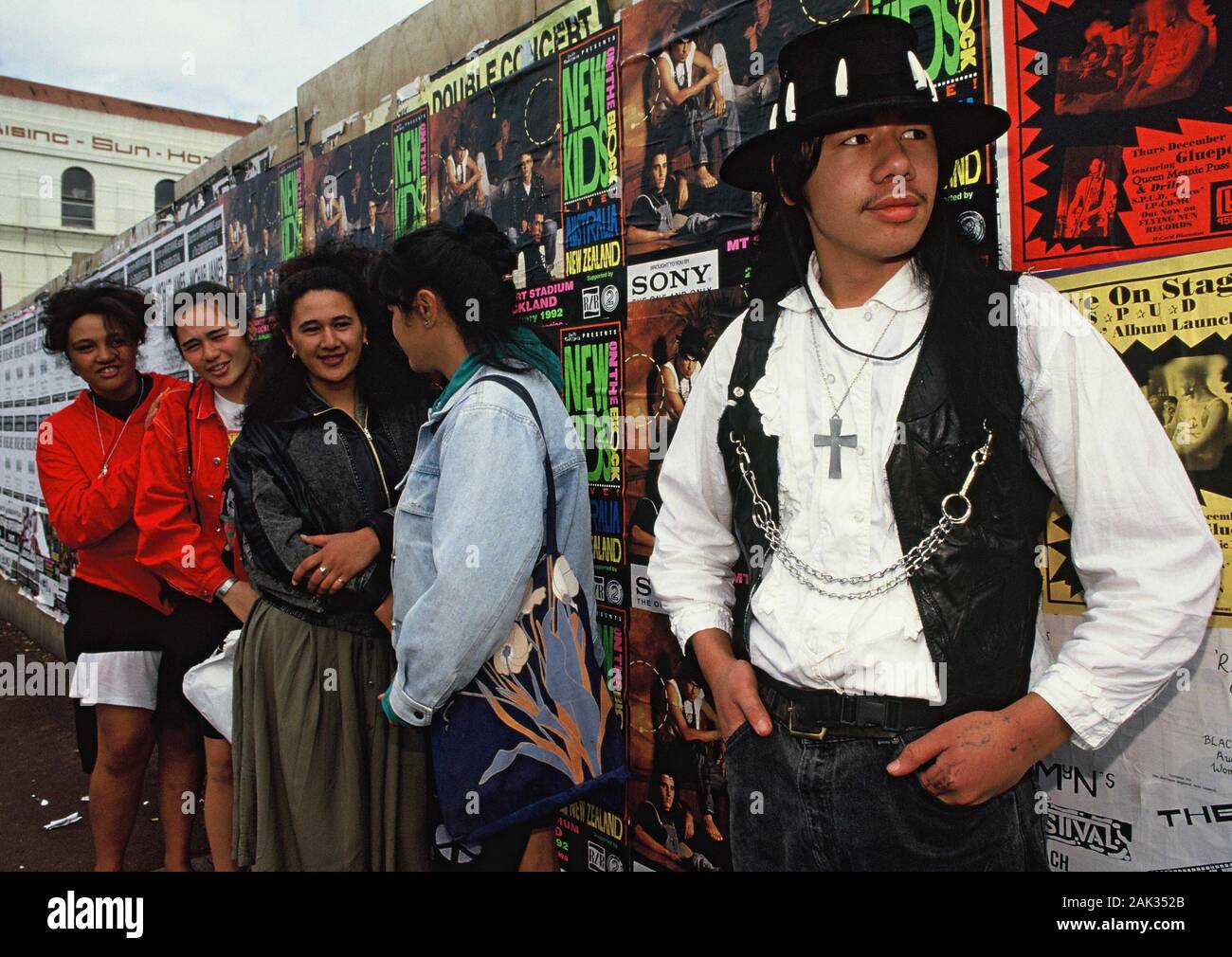 Young Maori standing together in front of a billboard in the ...
