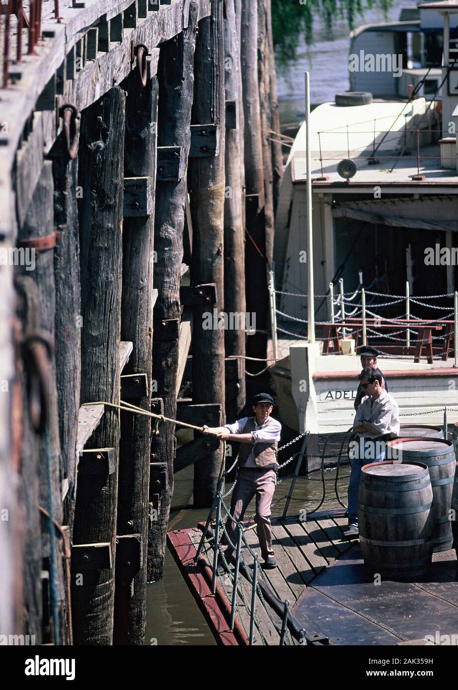 A man is mooring a paddle steamer at the historic port of Echuca at the ...